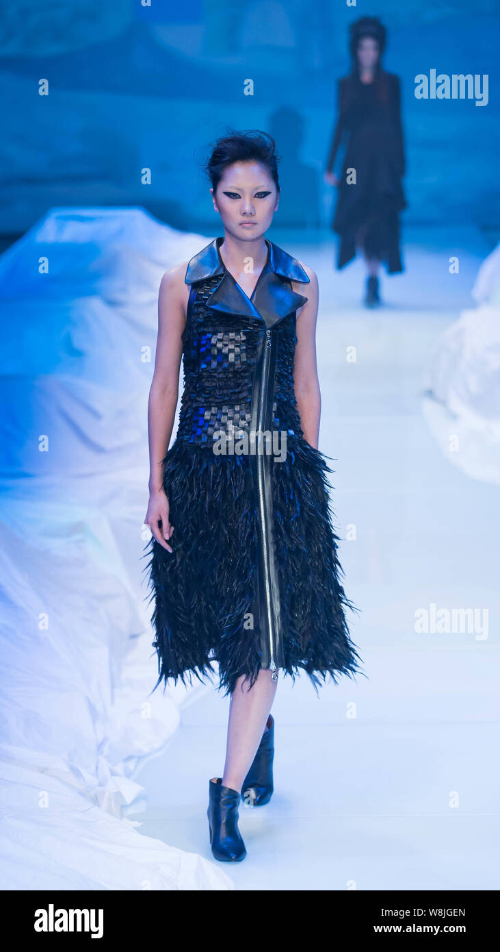 A model displays a new creation designed by Liu Shixi at the "The ...