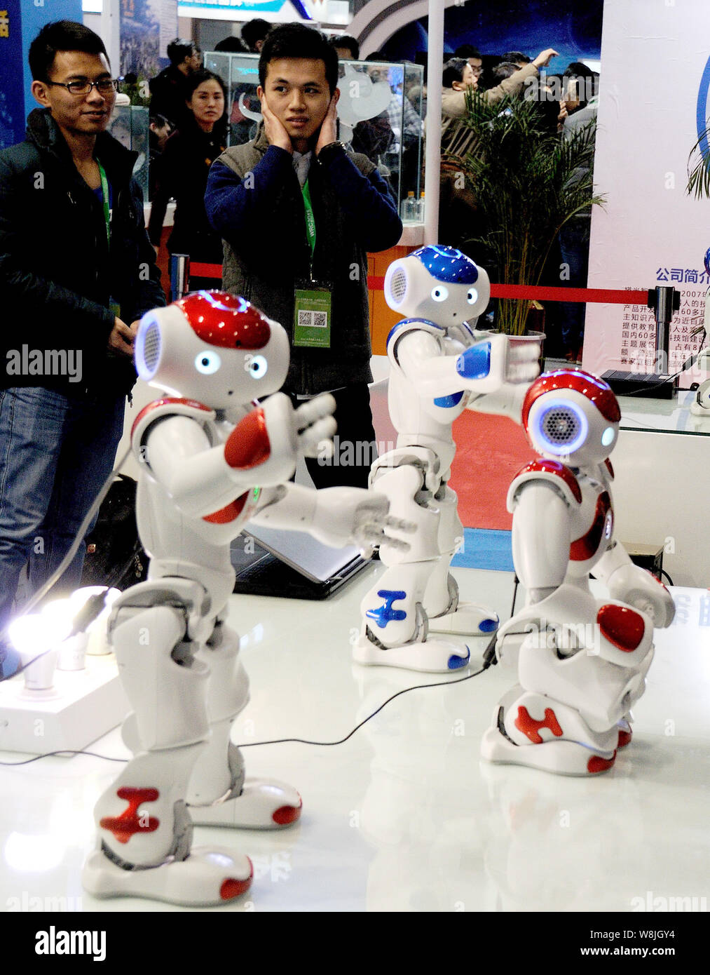 Visitors watch robots of Aldebaran Robotics dancing during the World ...