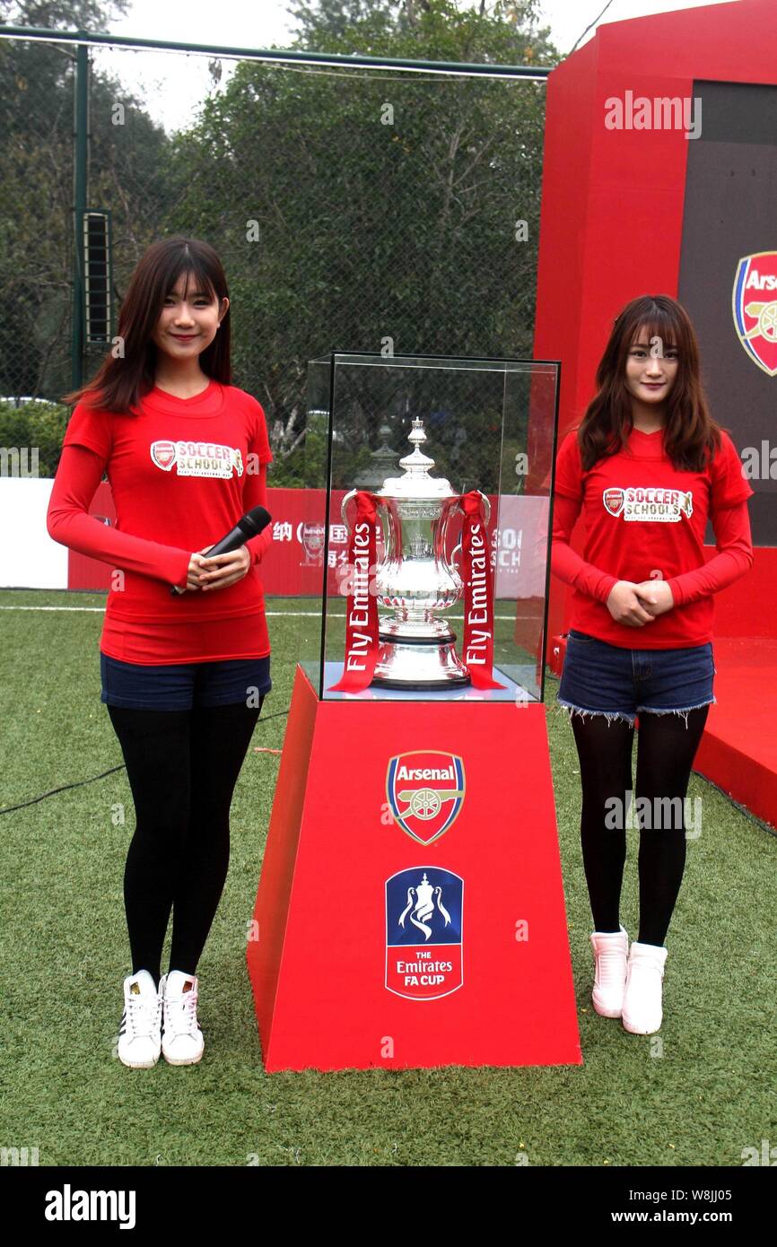 Chinese hostesses pose with the FA Cup Trophy during the Arsenal ...
