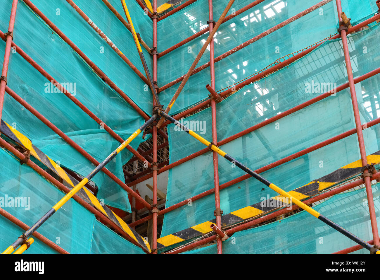 corner of scaffolding and protection netting on an unfinished building ...