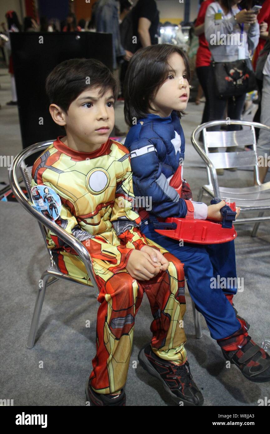 Two young boys dressed in Iron Man and American Captain costumes pose ...