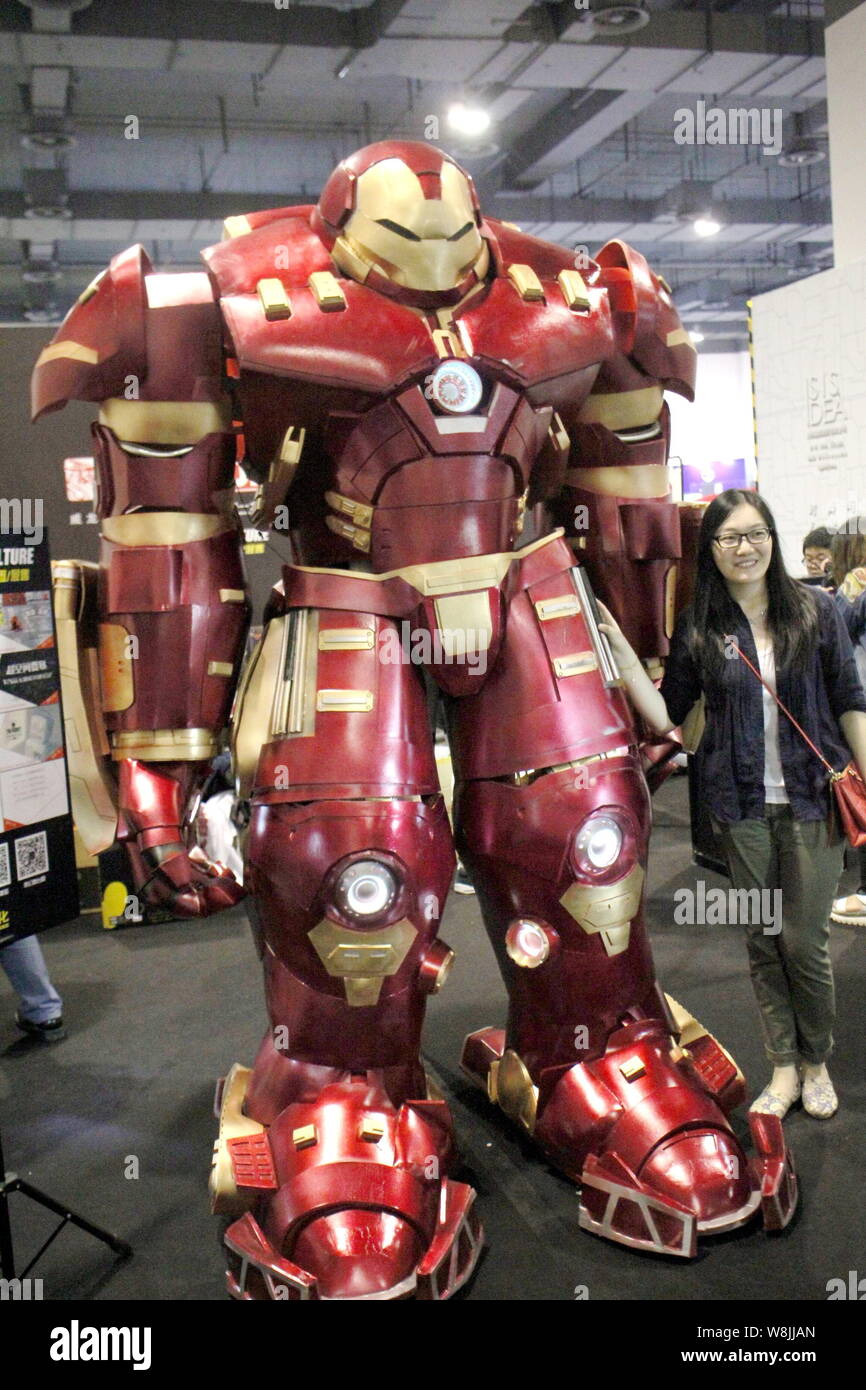 A visitor poses with a model ofo the Hulkbuster armor at the 12th ...