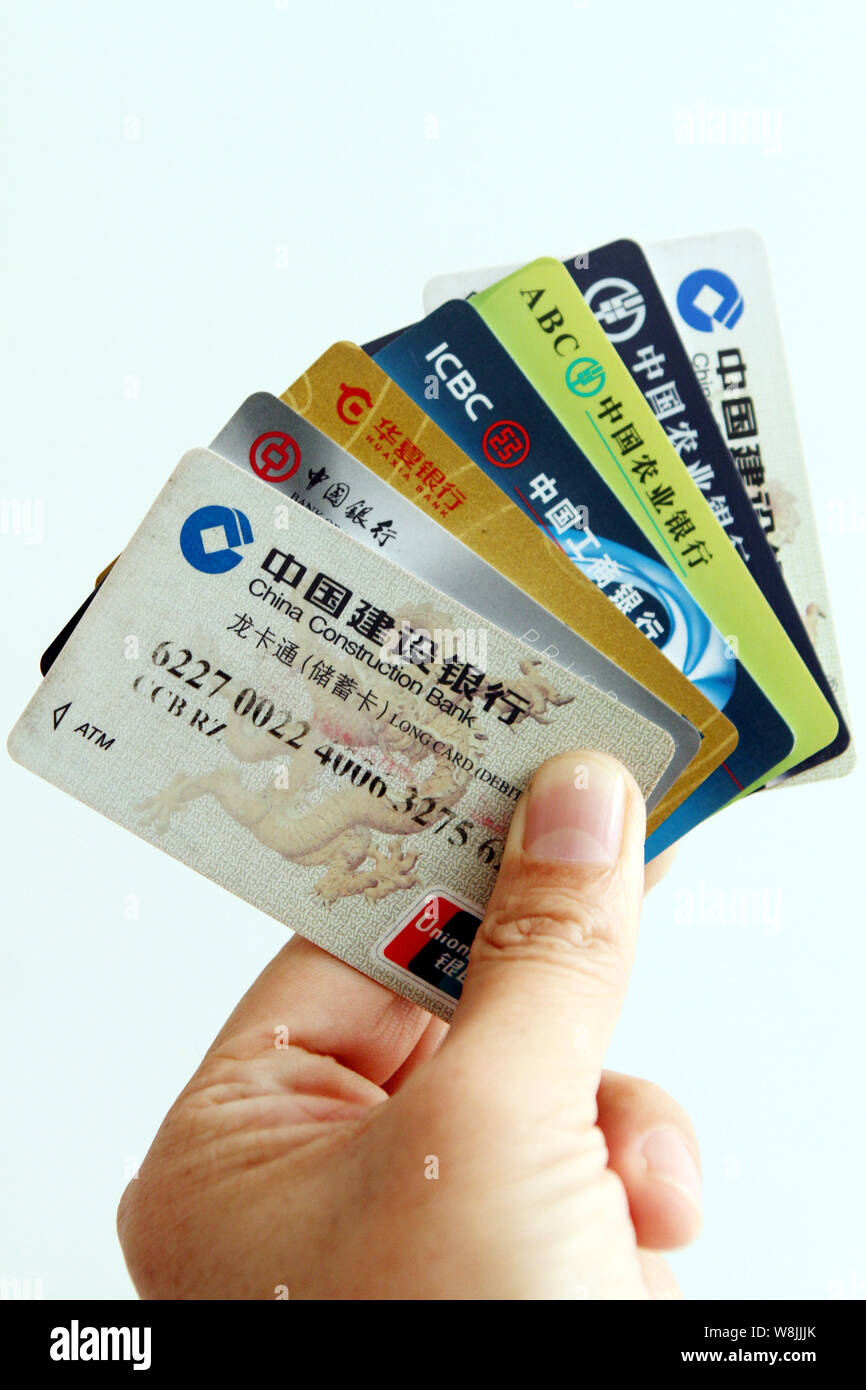 --FILE--A Chinese man shows his bank cards in Rizhao city, east China's ...