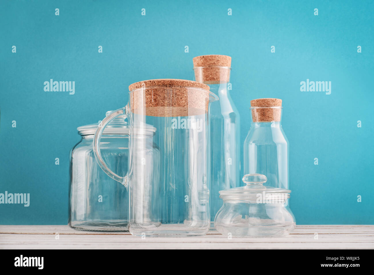 Glass kitchen utensils on blue background closeup Stock Photo - Alamy