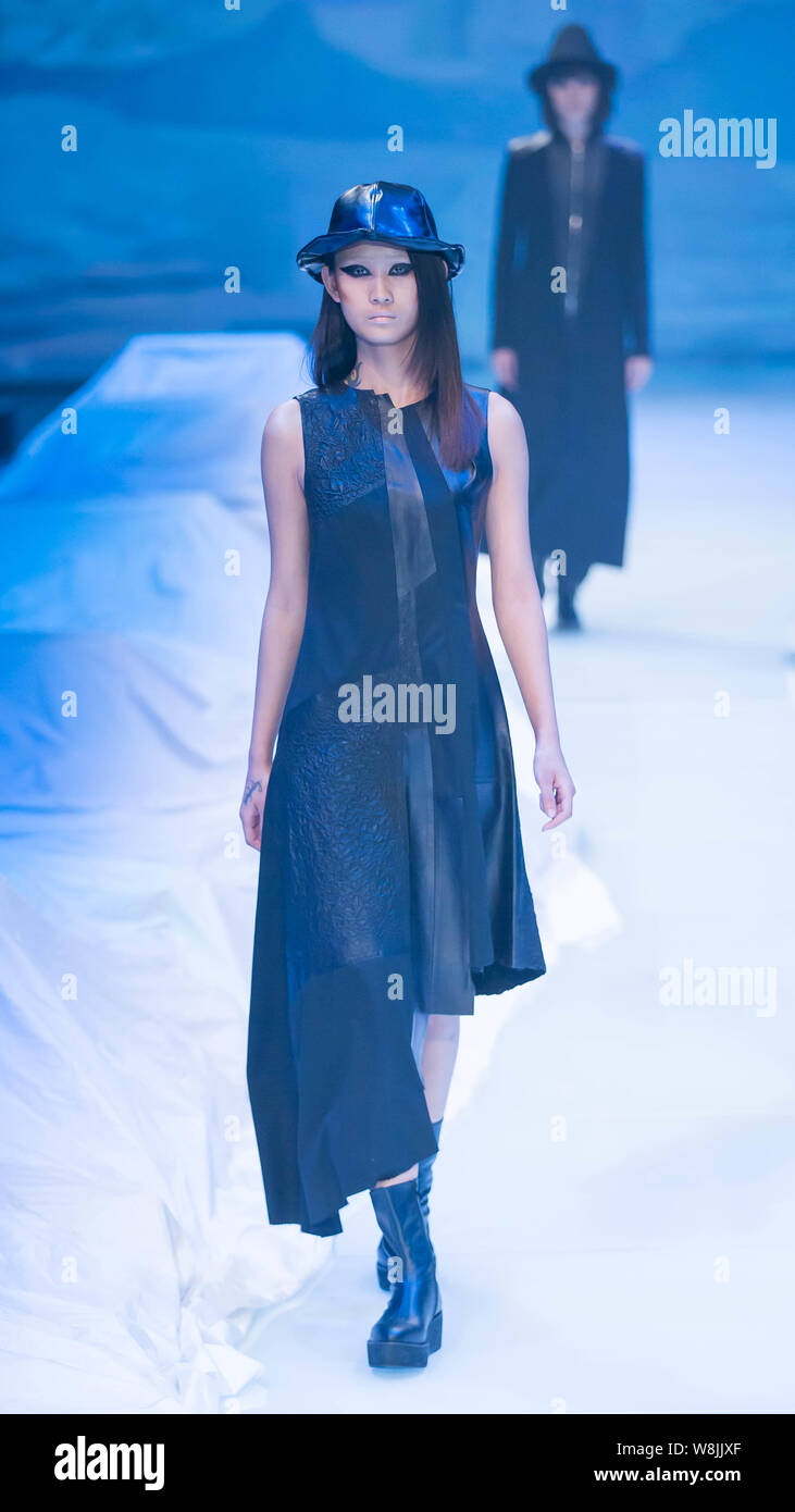 A model displays a new creation designed by Liu Shixi at the "The ...