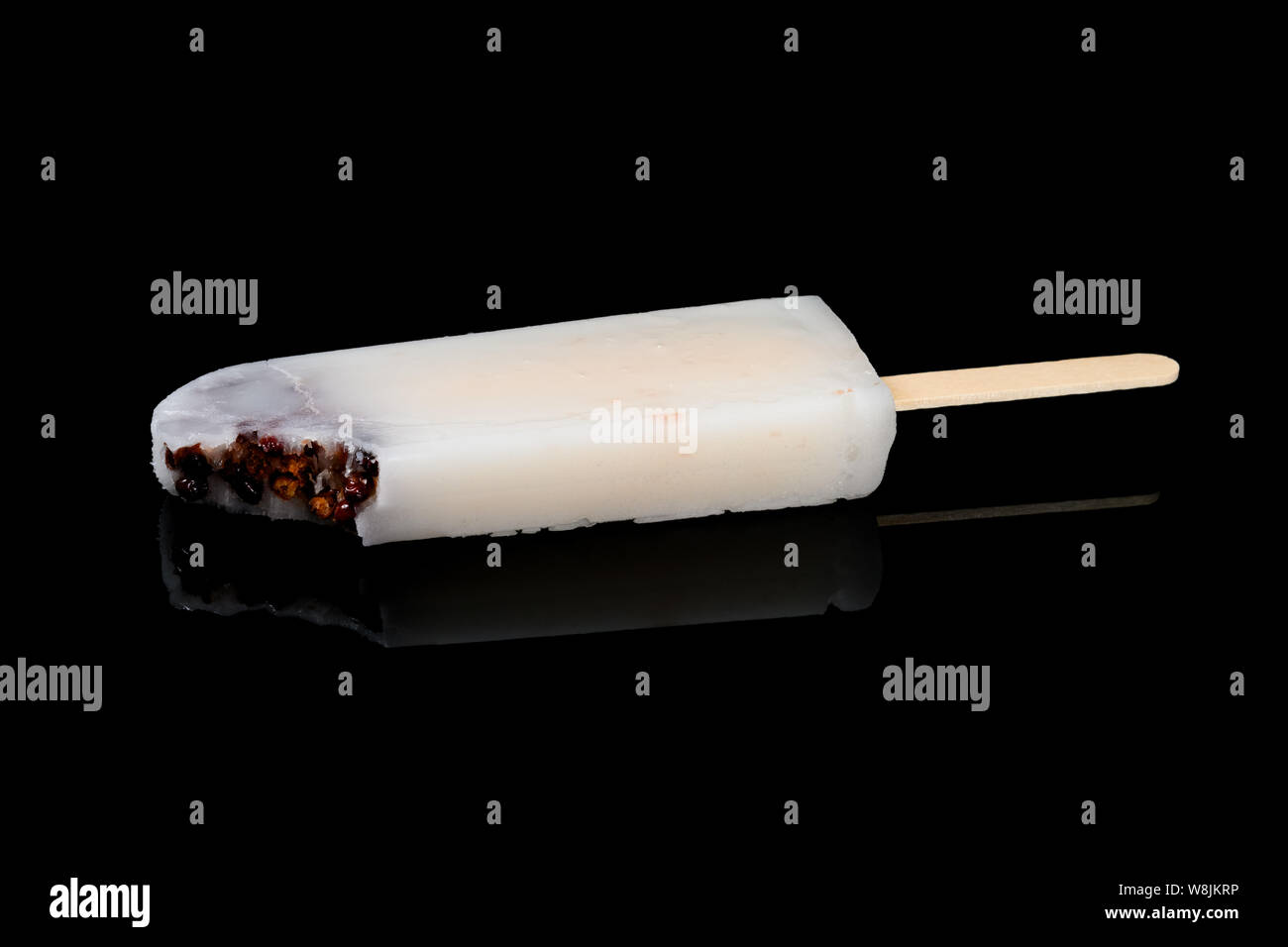 red bean popsicle with a bite on black background Stock Photo - Alamy