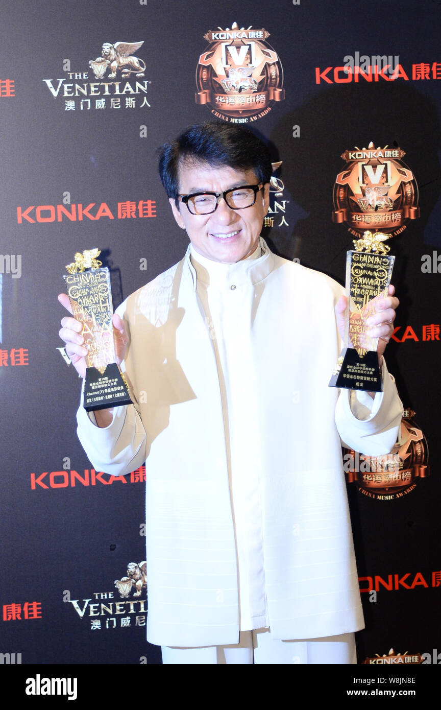 Hong Kong kungfu star Jackie Chan poses with his trophies after the ...