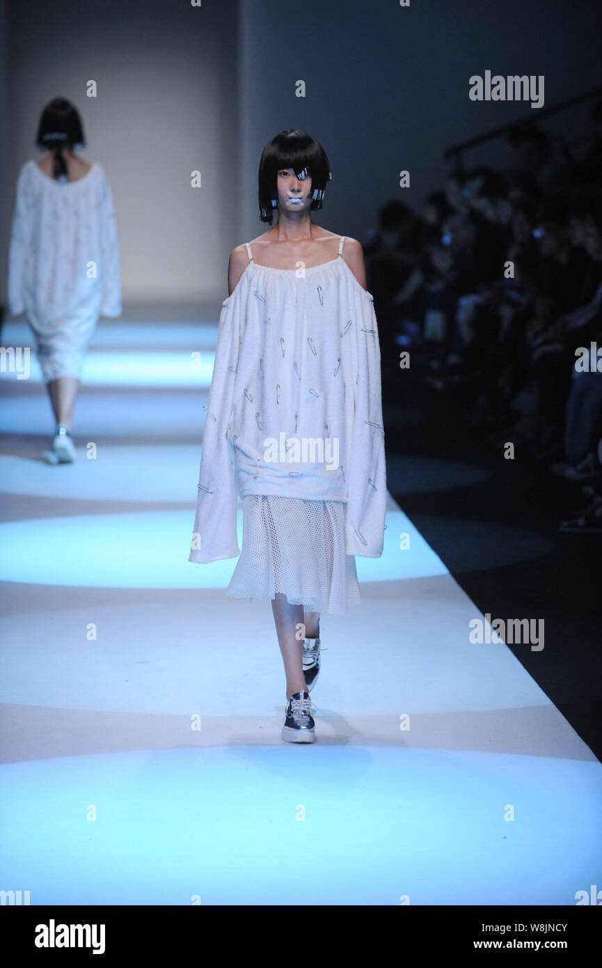 A model displays a new creation at the Zhang Yuhao fashion show during ...