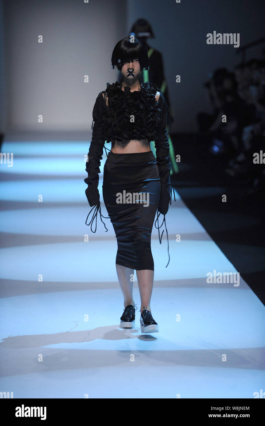 A model displays a new creation at the Zhang Yuhao fashion show during ...