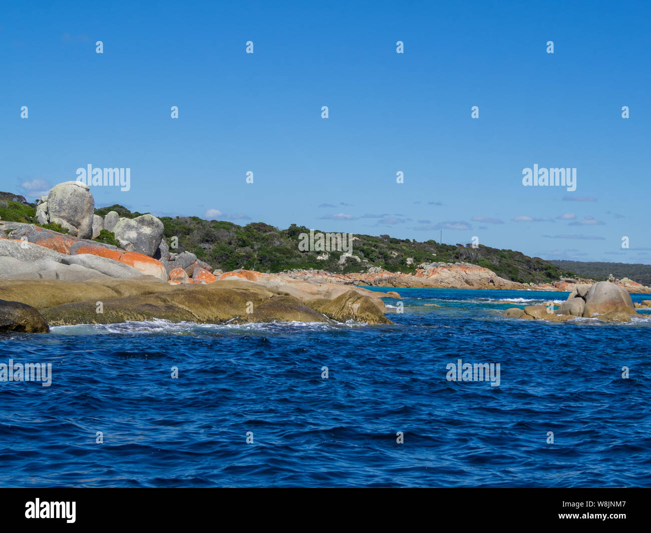 Red lichen covered rocks in Bay of Fires, Tasmania Stock Photo - Alamy