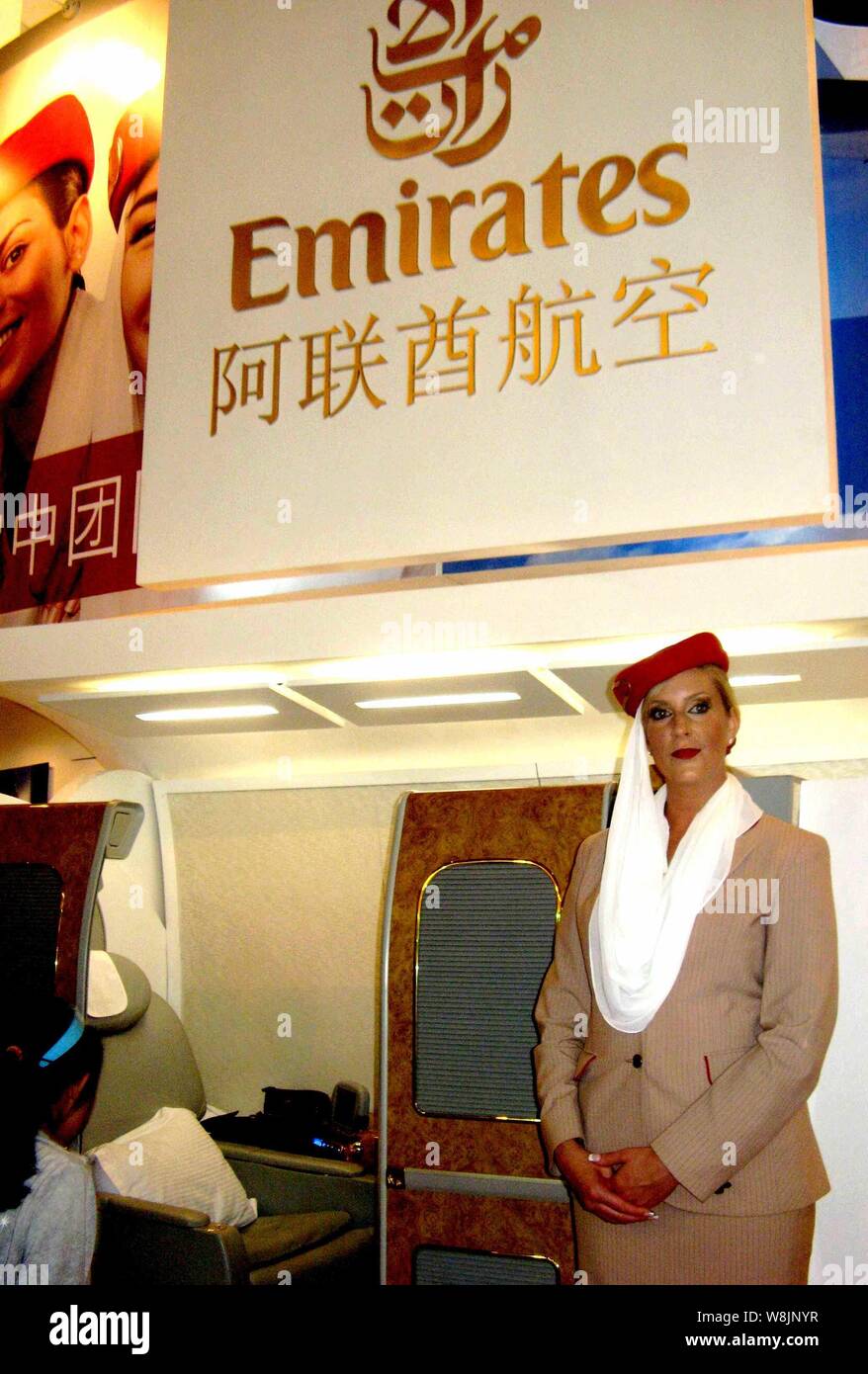 --FILE--A foreign employee poses at the stand of Emirates Airline ...