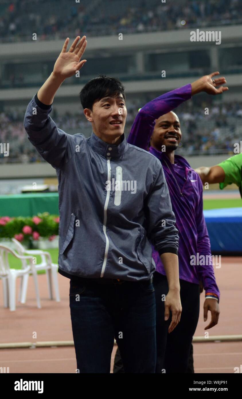 Chinese hurdler Liu Xiang, left, waves during his retirement ceremony ...