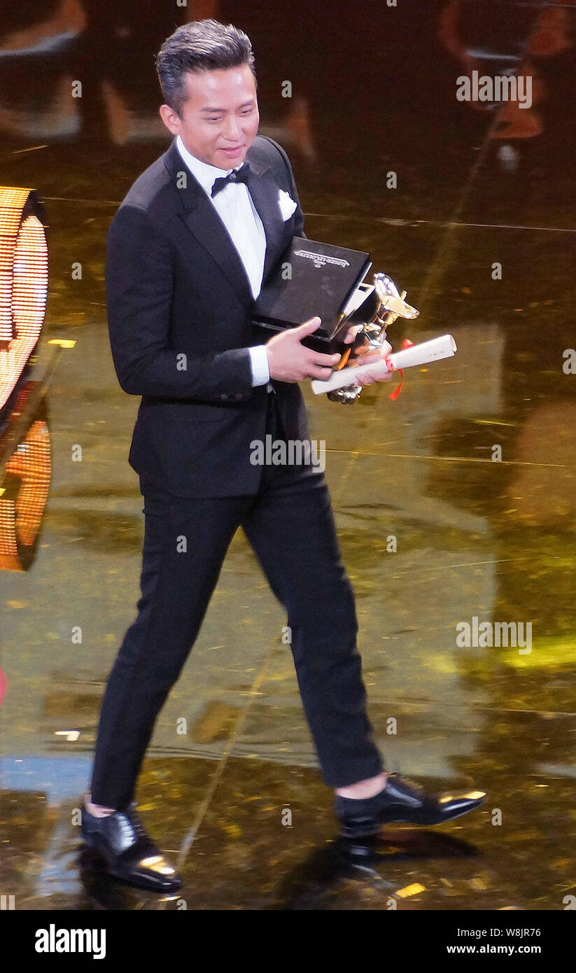 Chinese actor Deng Chao holds his trophy after winning the Best Actor ...