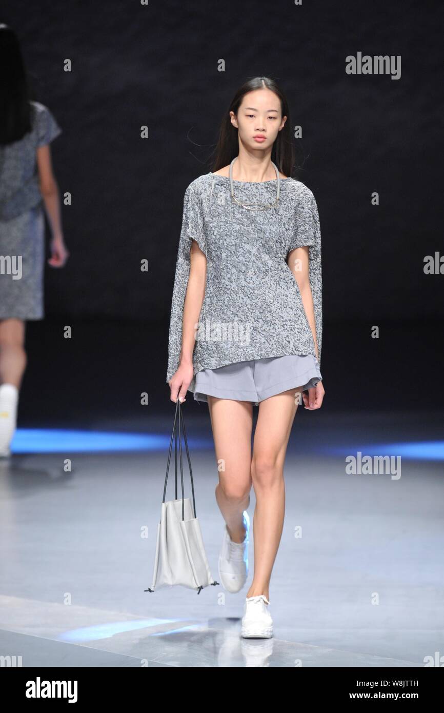 A model displays a new creation at the Harrison Wong fashion show of ...