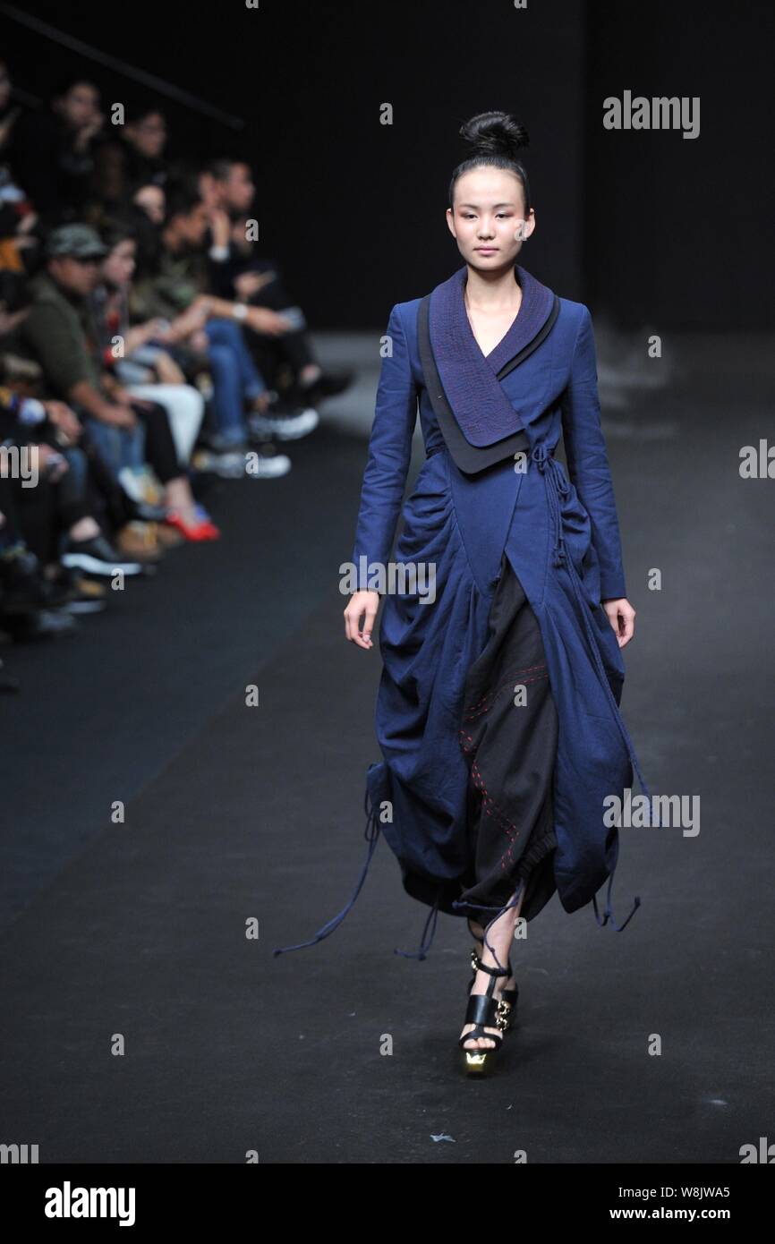 A model displays a new creation by fashion designer Li Shiyong at a ...
