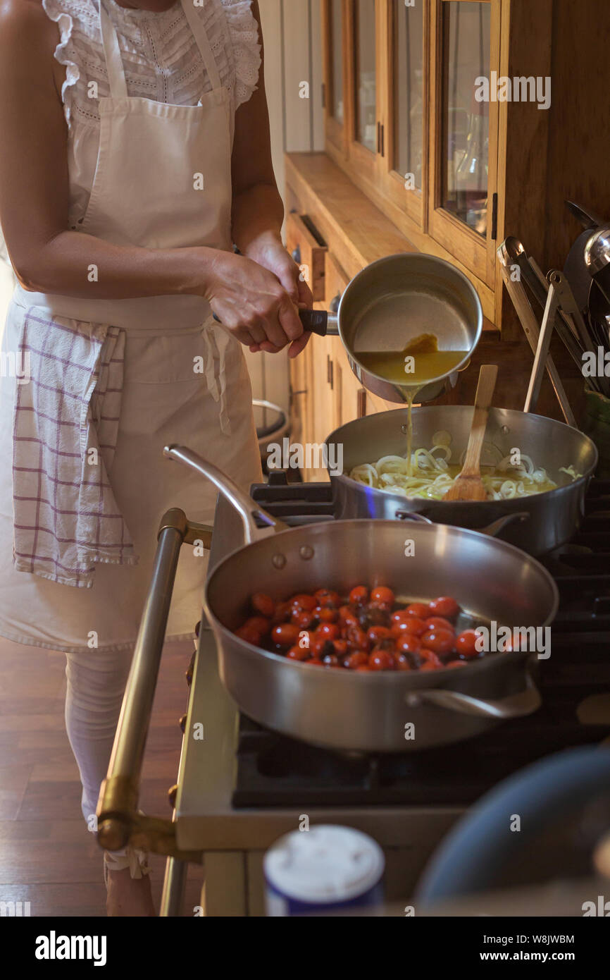 Pan with caramelised tomatoes cherry process of cooking and adding ...