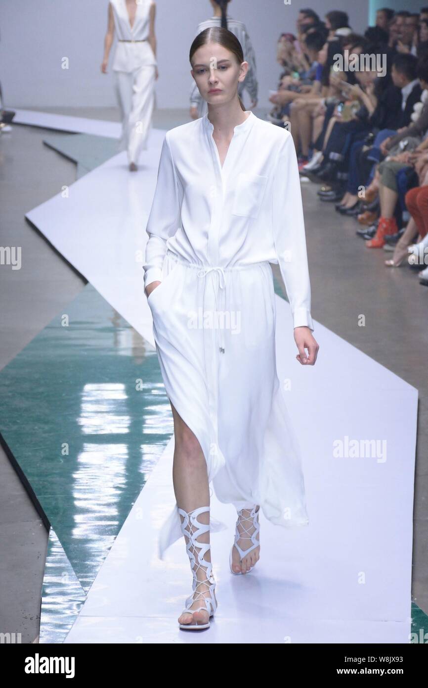 A model displays a new creation at the fashion show for the Spring ...
