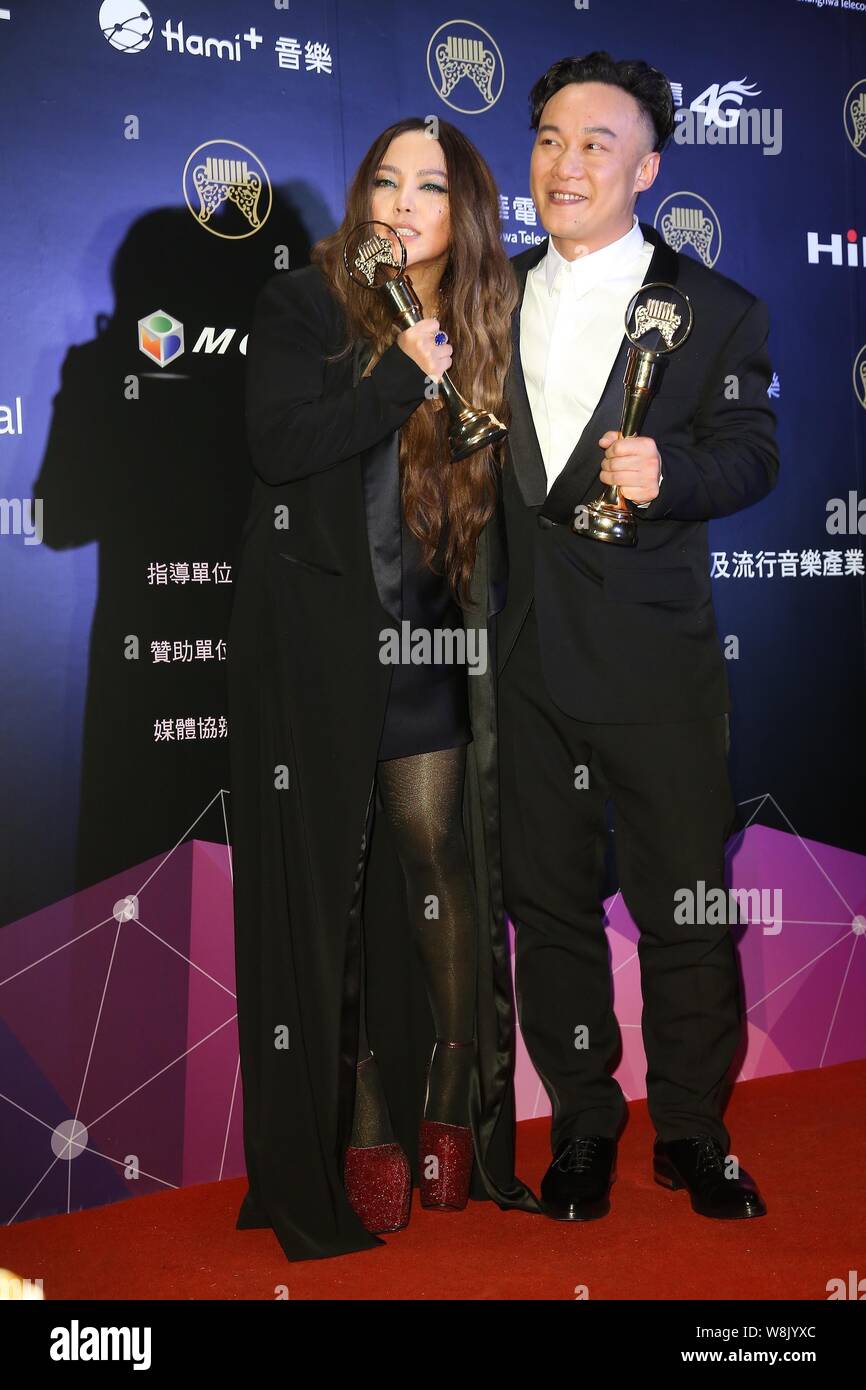 Taiwanese singer A Mei, left, and Hong Kong singer Eason Chan hold ...