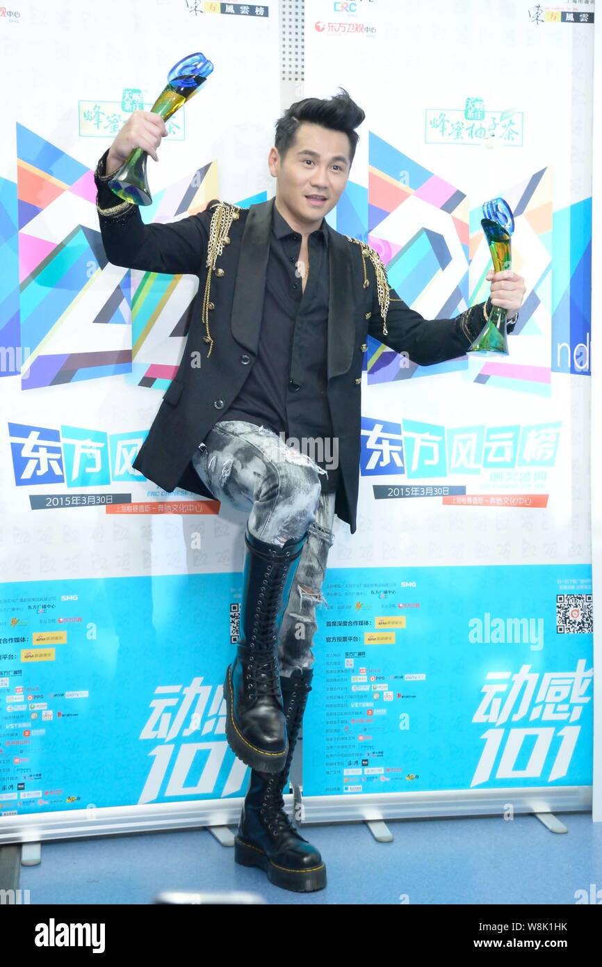 Taiwanese singer Gary Chaw poses with his trophies during the 22th ...