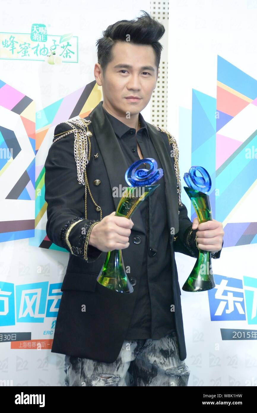Taiwanese singer Gary Chaw poses with his trophies during the 22th ...