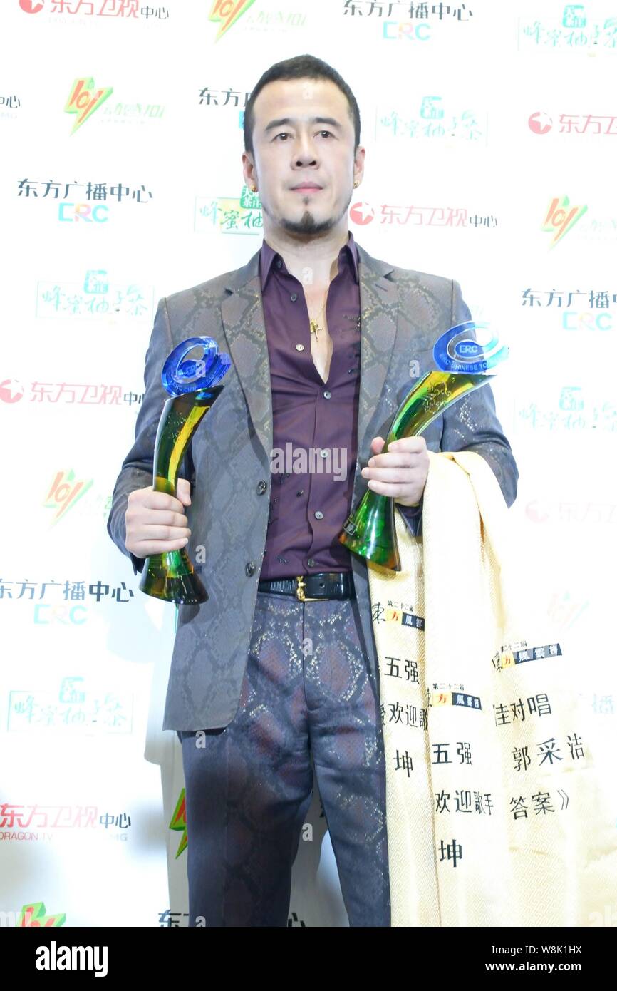 Chinese singer Yang Kun poses with his trophies during the 22th ...
