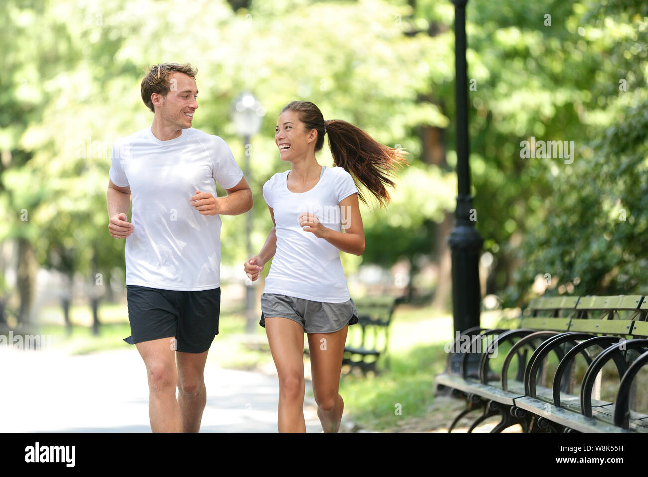 Runners jogging together in New York City Central Park, USA. Healthy ...