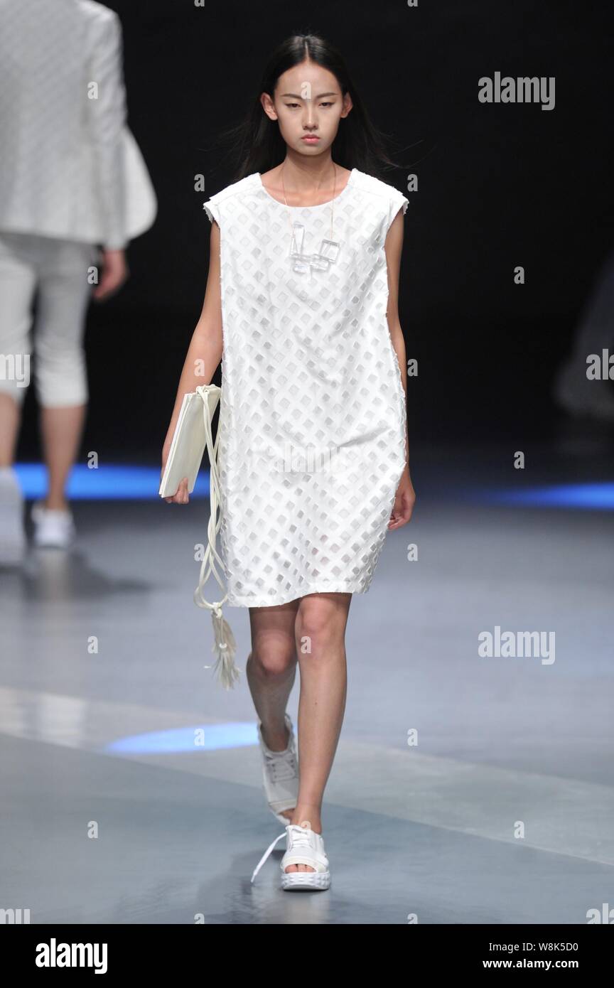 A model displays a new creation at the Harrison Wong fashion show of ...