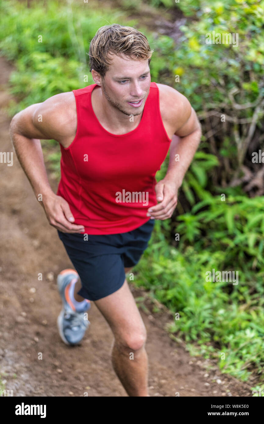 Runner trail running on tough mud race. Male athlete man training ...
