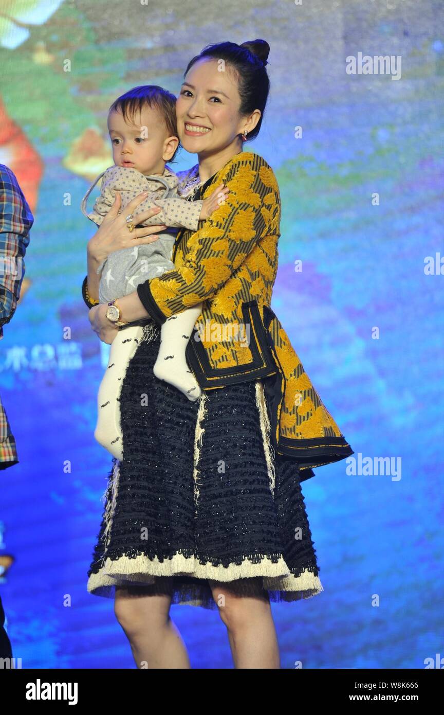 Chinese actress Zhang Ziyi poses with a little baby as a producer at a ...