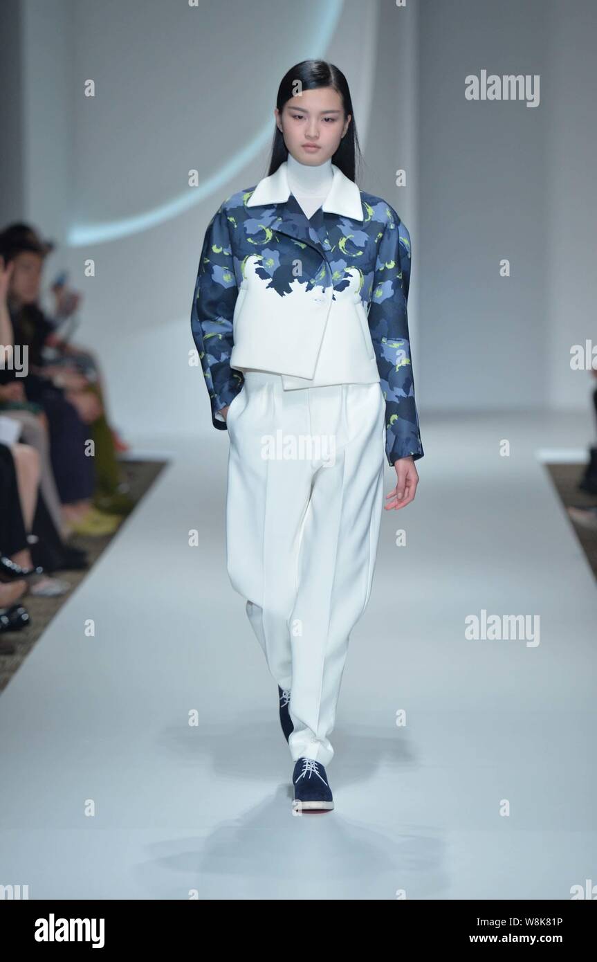 A model displays a new creation designed by Chinese model Lv Yan at ...