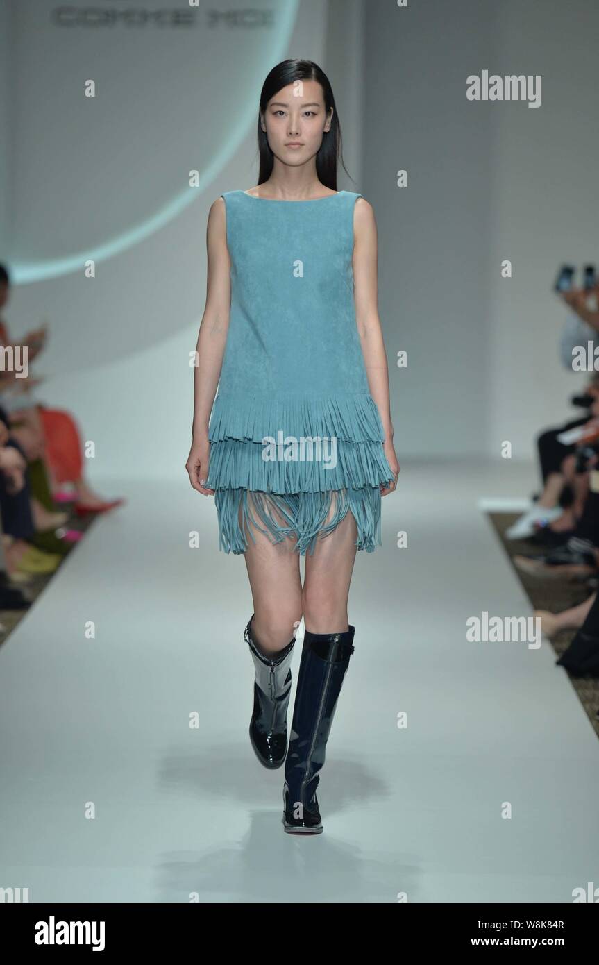 A model displays a new creation designed by Chinese model Lv Yan at ...