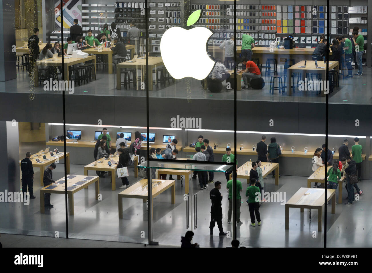 The leaf of the logo of Apple Inc. is illuminated in green at an Apple ...