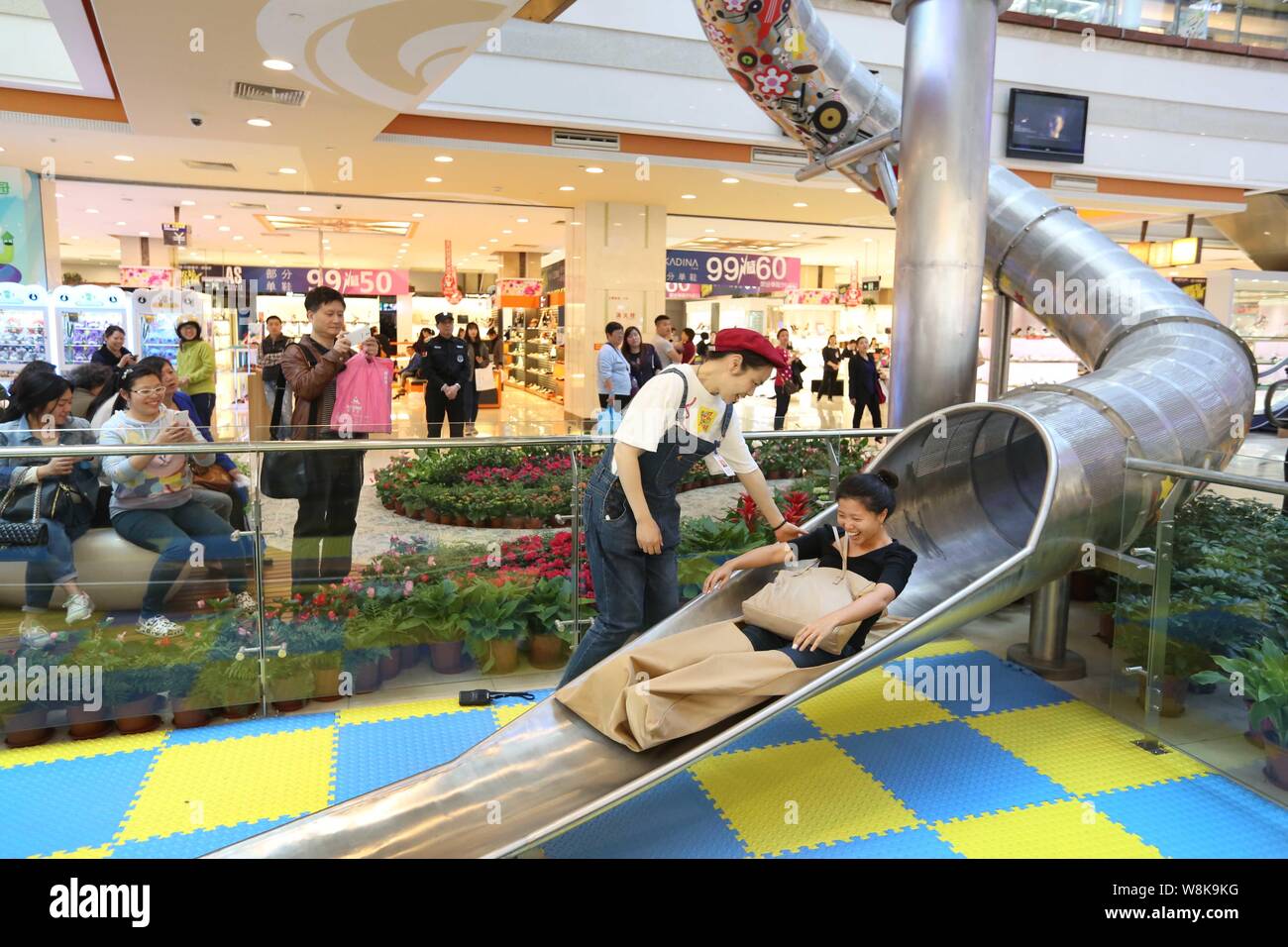 A woman tries out the five-story-high giant winding slide during a ...