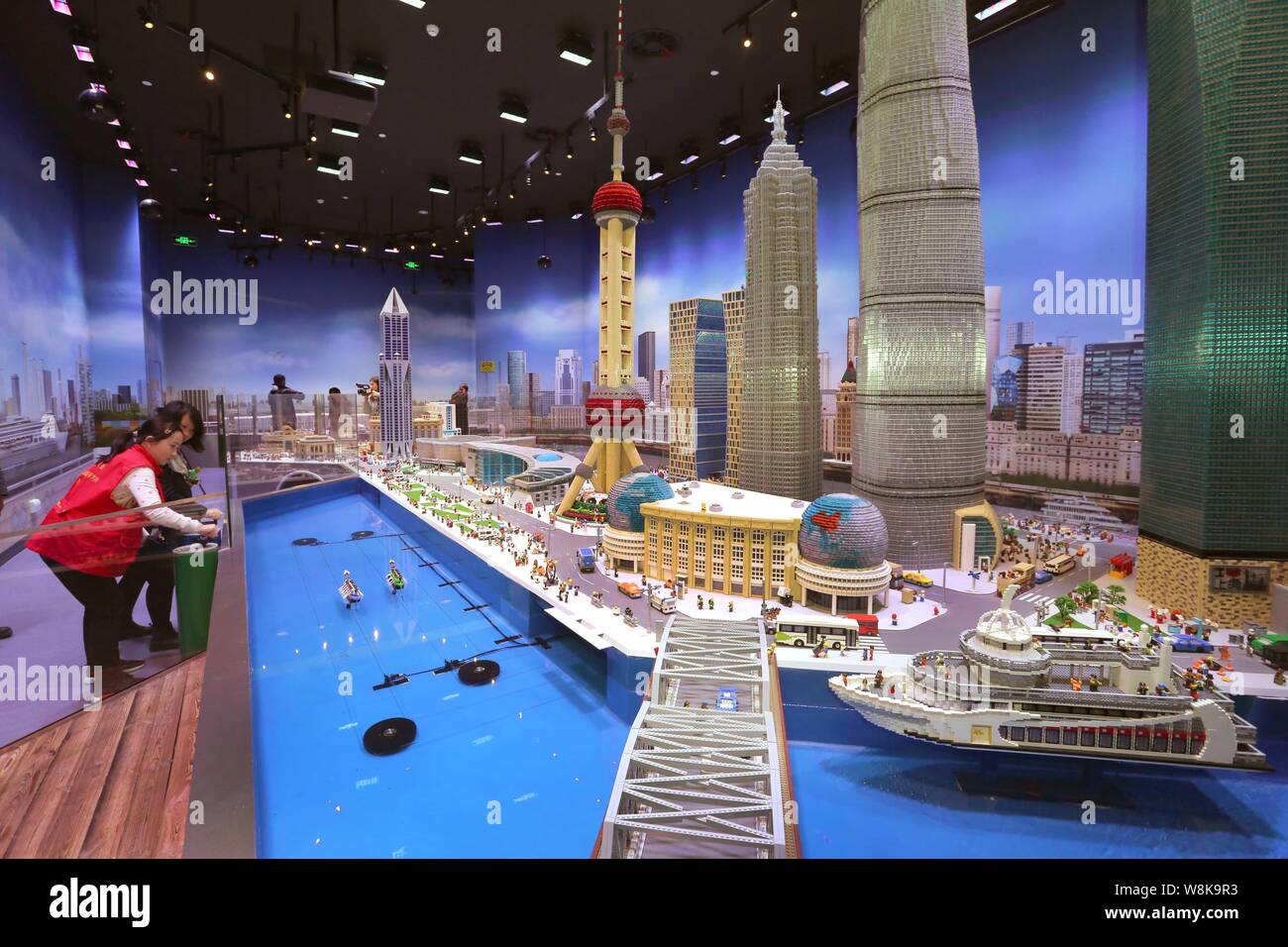Visitors look at Shanghai's landmark buildings made with Lego bricks at ...