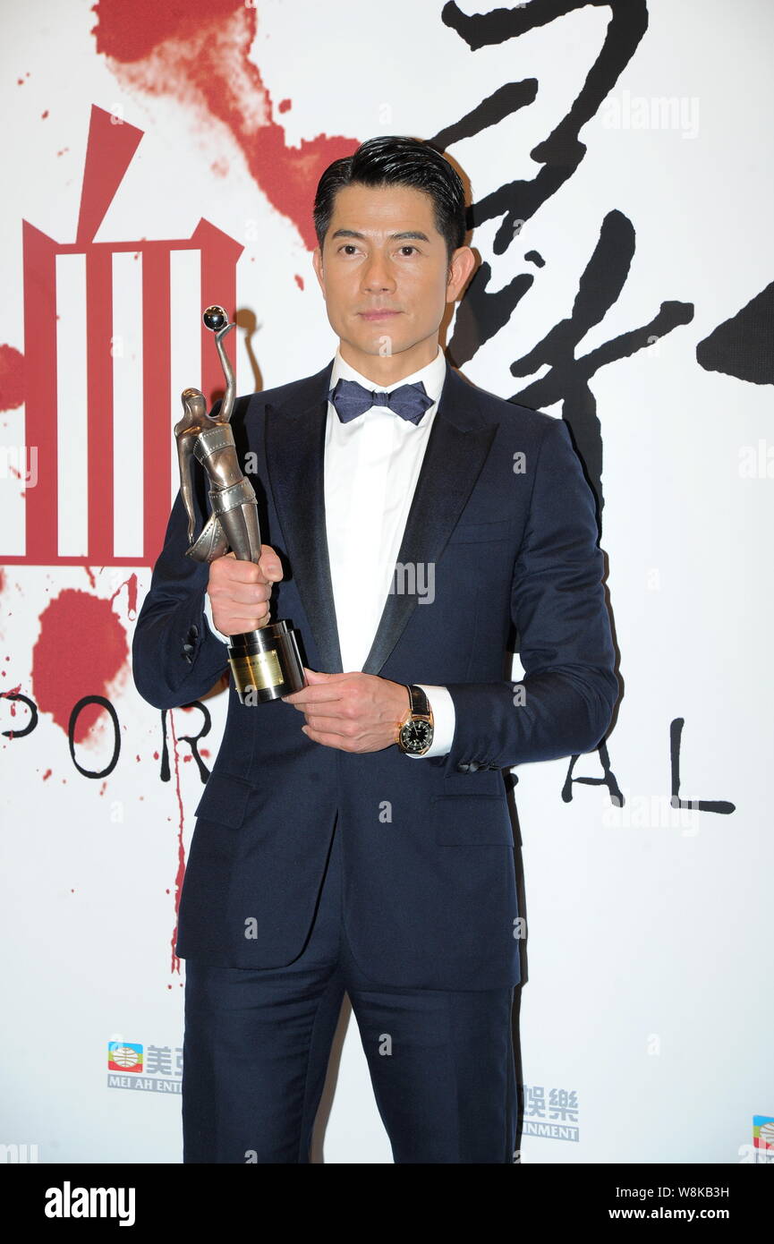Hong Kong actor Aaron Kwok poses with his trophy for the Best Actor ...