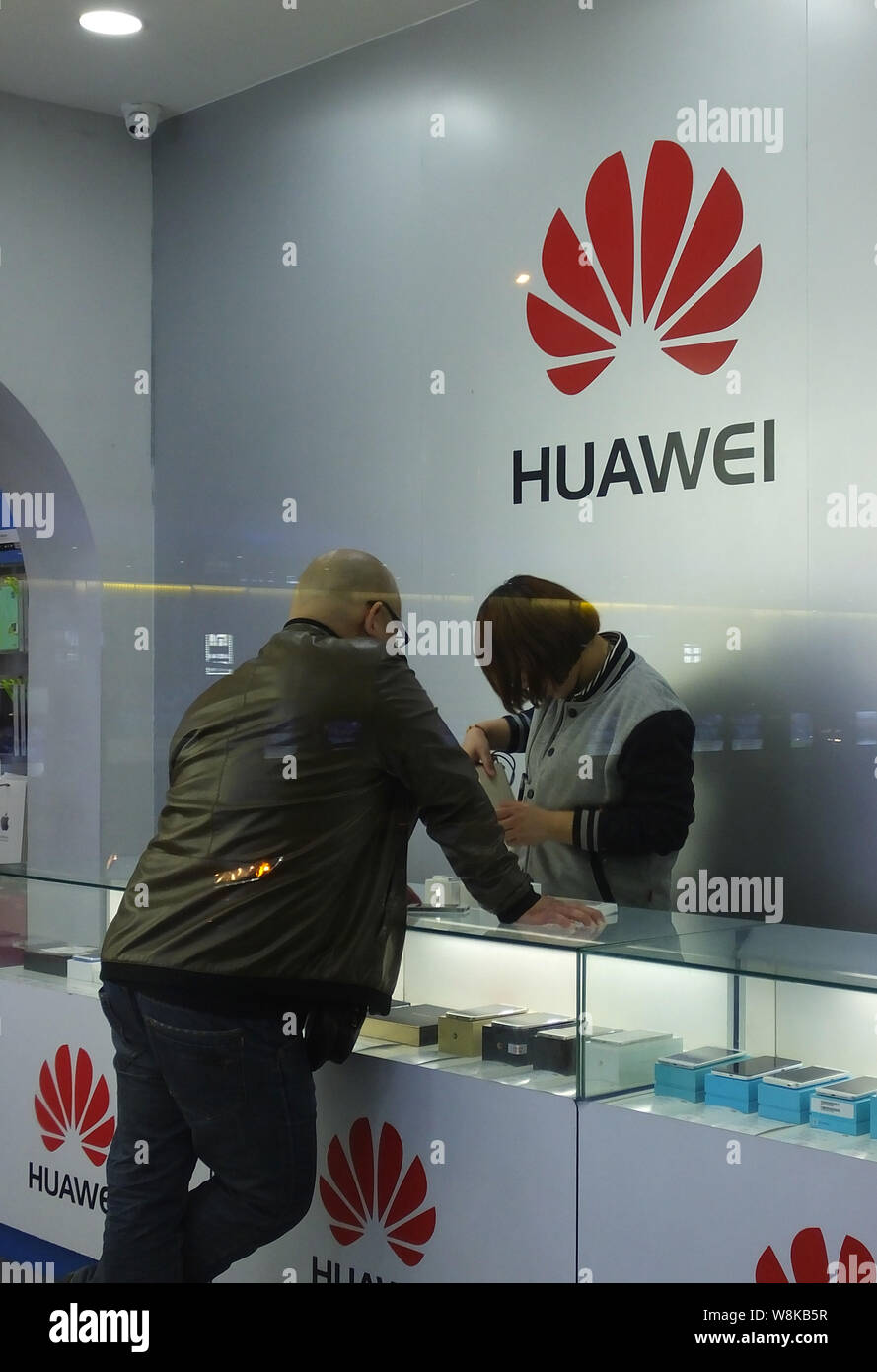 --FILE--A customer shops for smartphones at a mobile phone store of ...