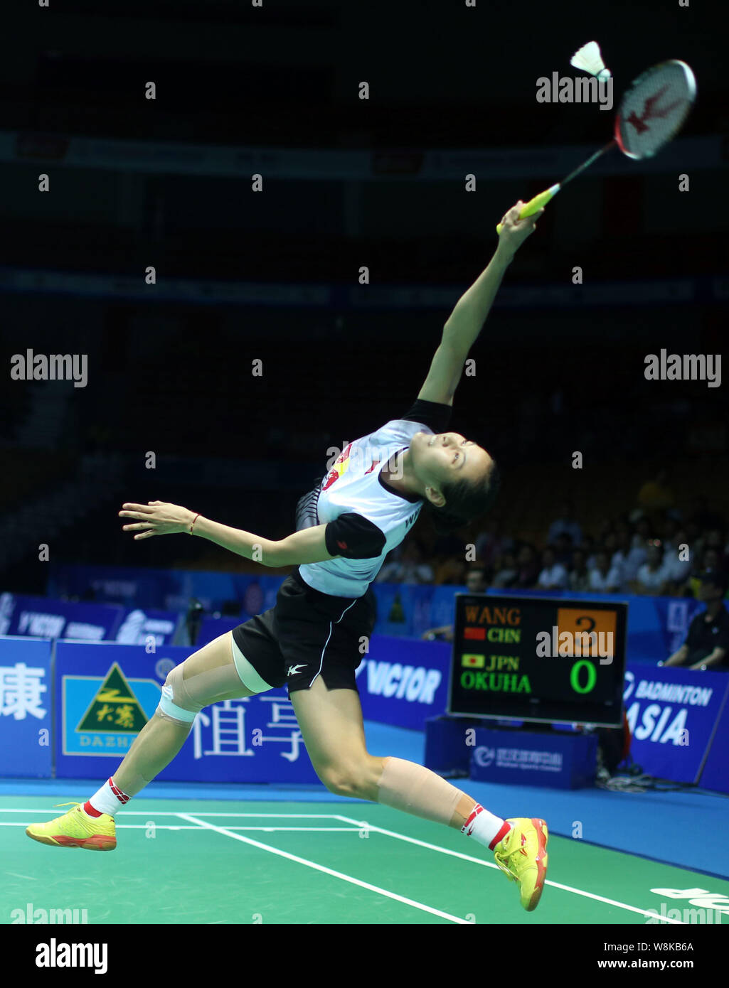 Wang Yihan of China returns a shot to Nozomi Okuhara of Japan in their ...
