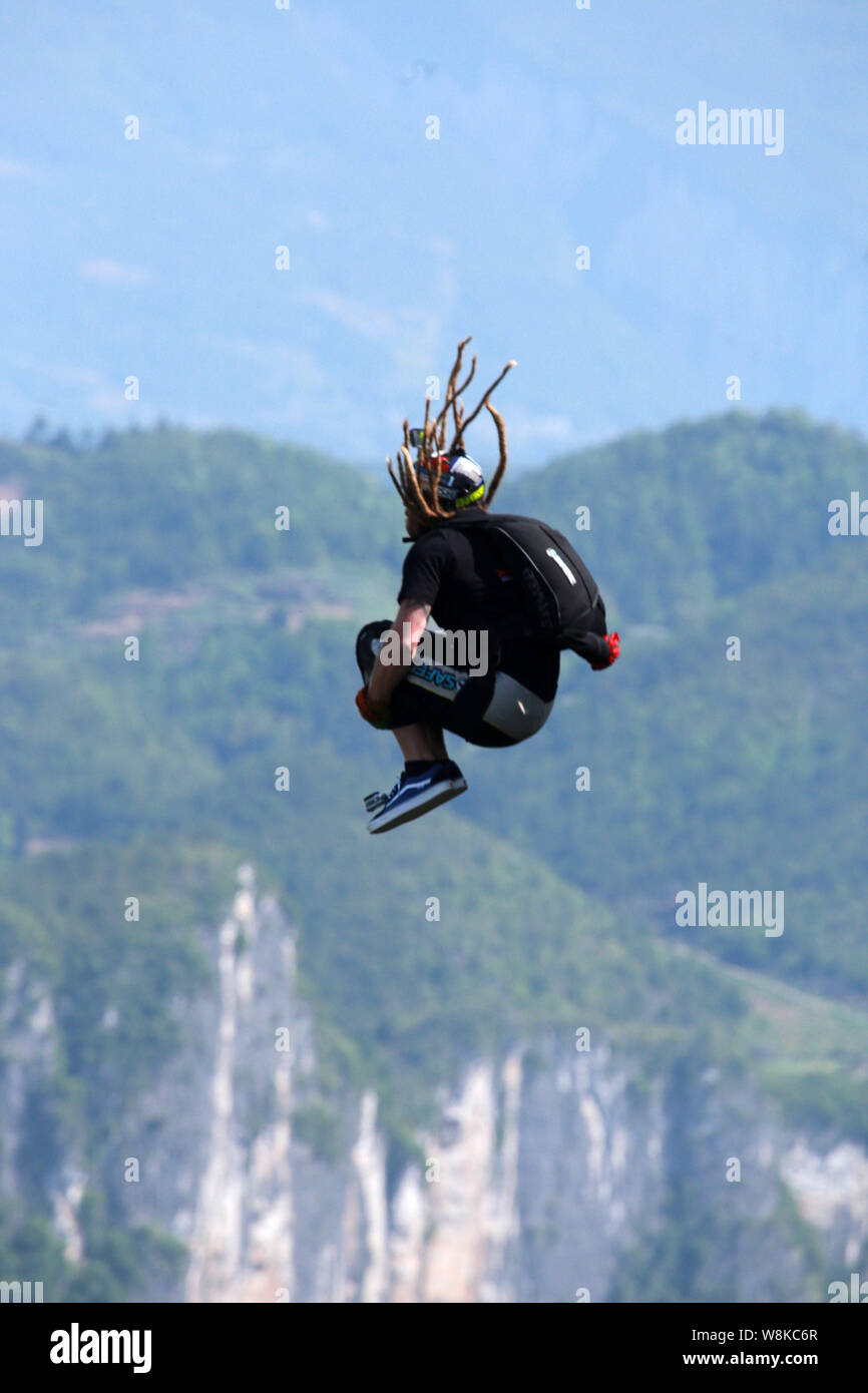 A contestant jumps off the glass cantilever bridge on the cliff during ...