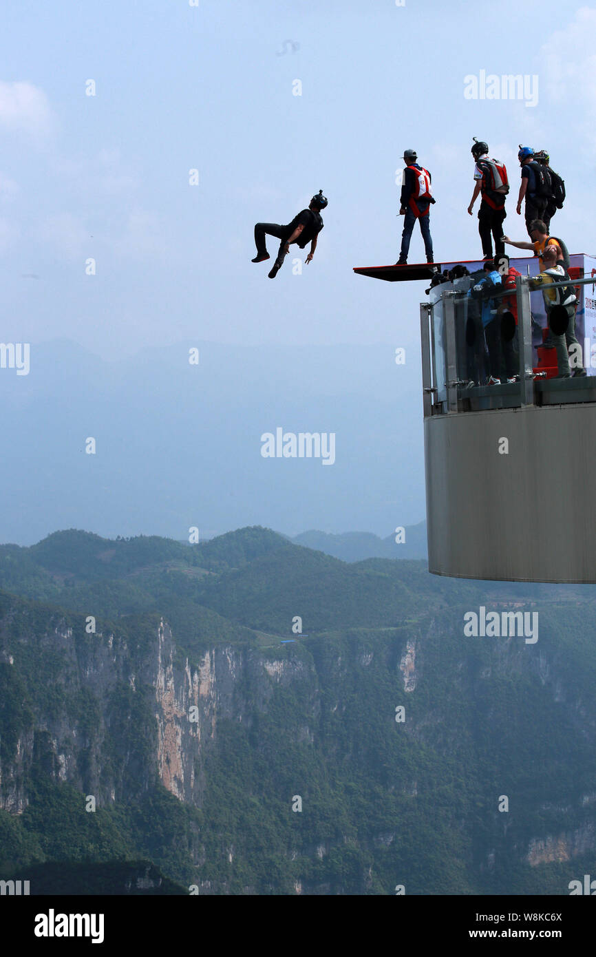 A contestant jumps off the glass cantilever bridge on the cliff during ...