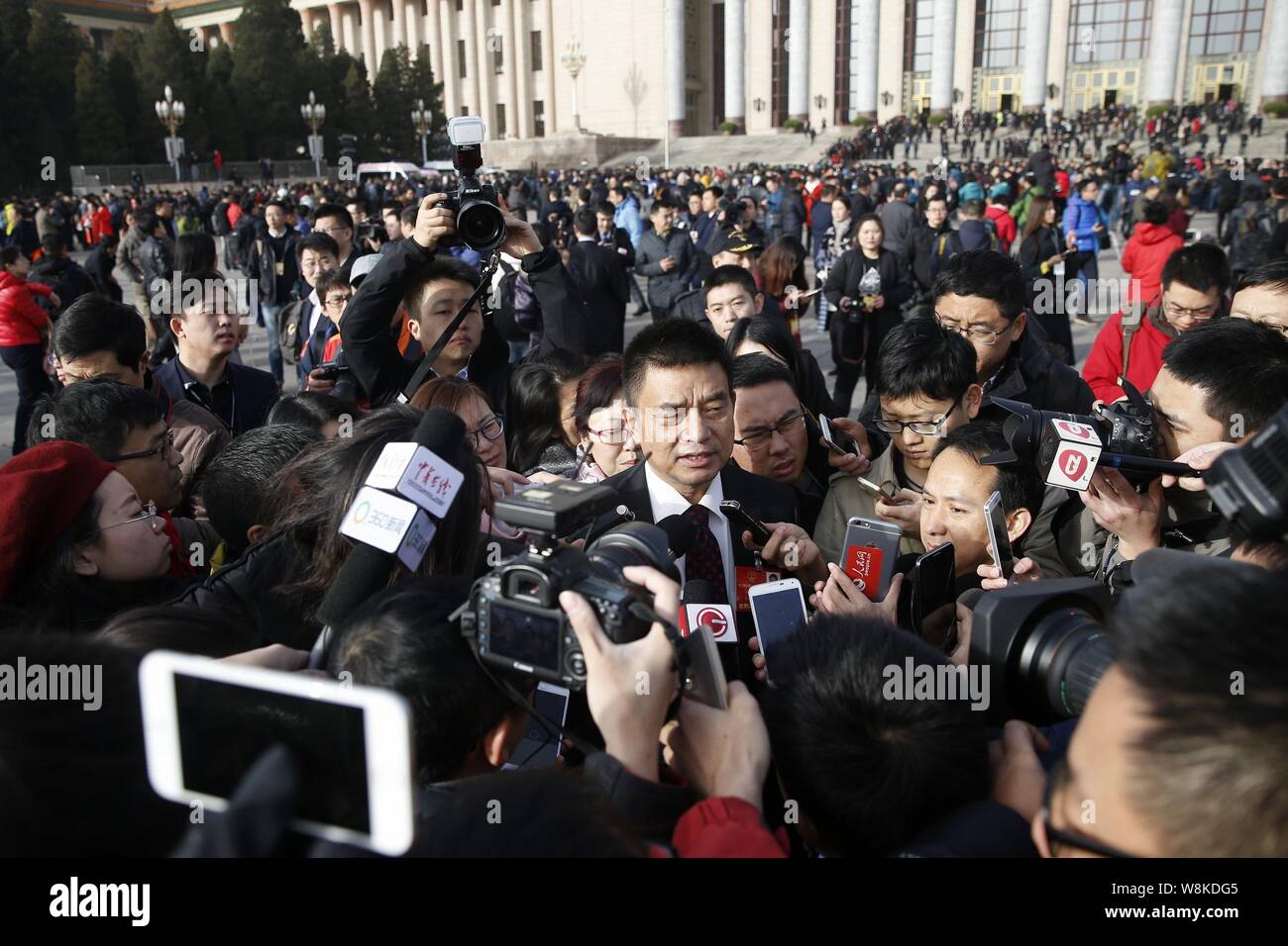 Liu Yonghao, center, Chairman of New Hope Group, is interviewed as he ...