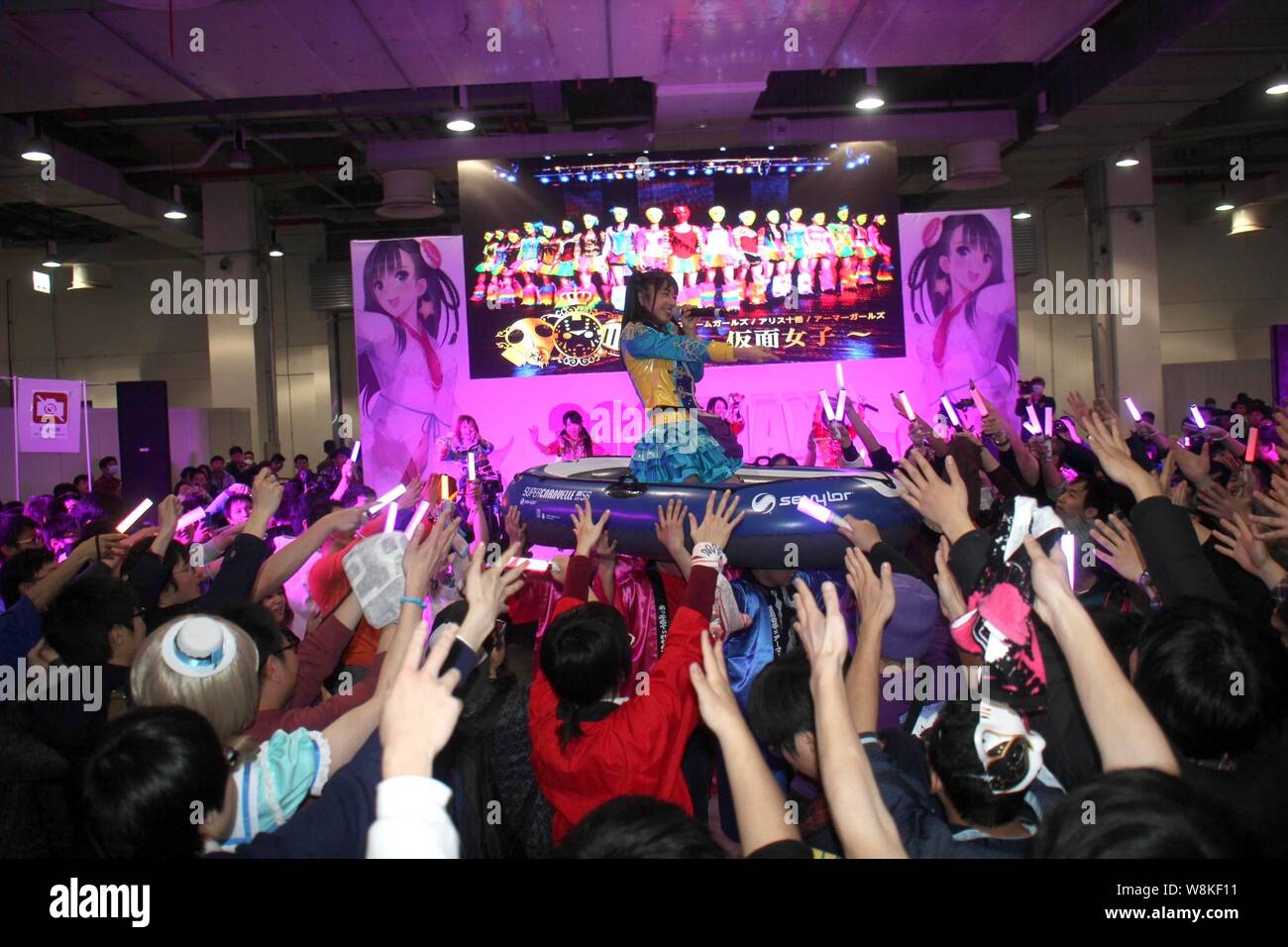 Members of Japanese idol girl group Kamen Joshi, literally "Masked Girls", perform during the ...