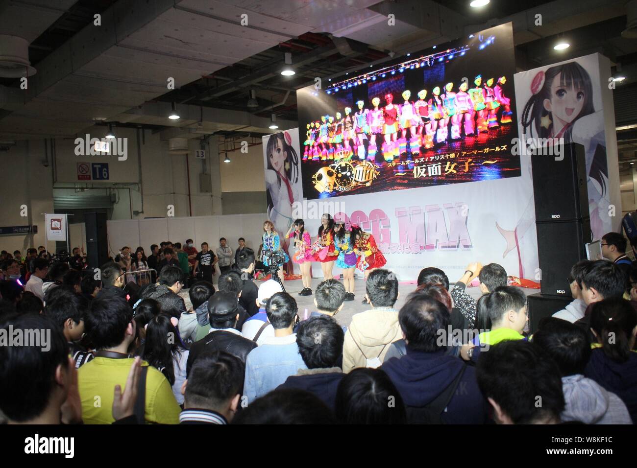 Members of Japanese idol girl group Kamen Joshi, literally "Masked Girls", perform during the ...