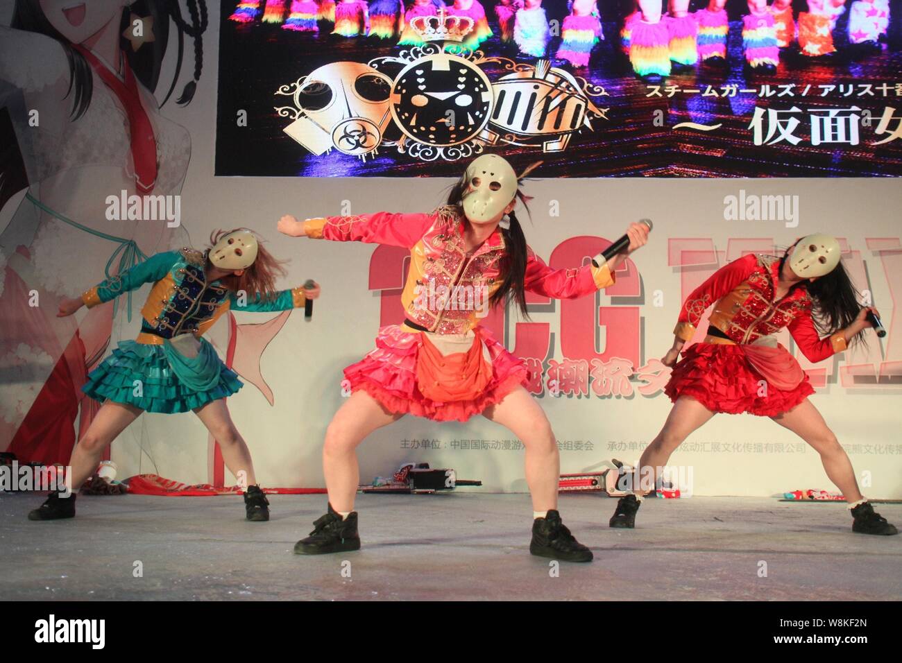 Members of Japanese idol girl group Kamen Joshi, literally "Masked Girls", perform during the ...
