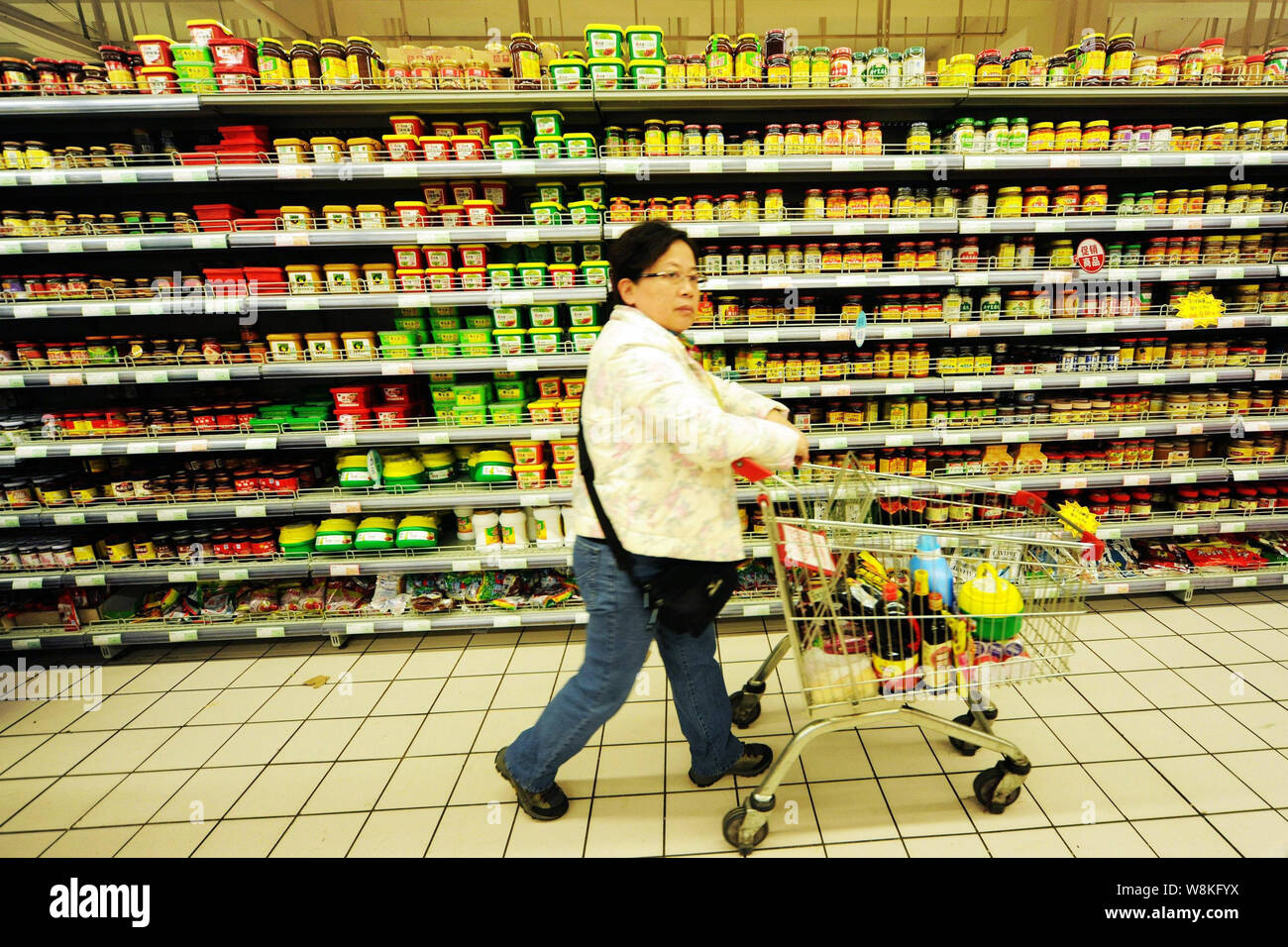 A Chinese customer is shopping at a supermarket in Qingdao city, east ... A Chinese customer is shopping at a supermarket in Qingdao city, east ...