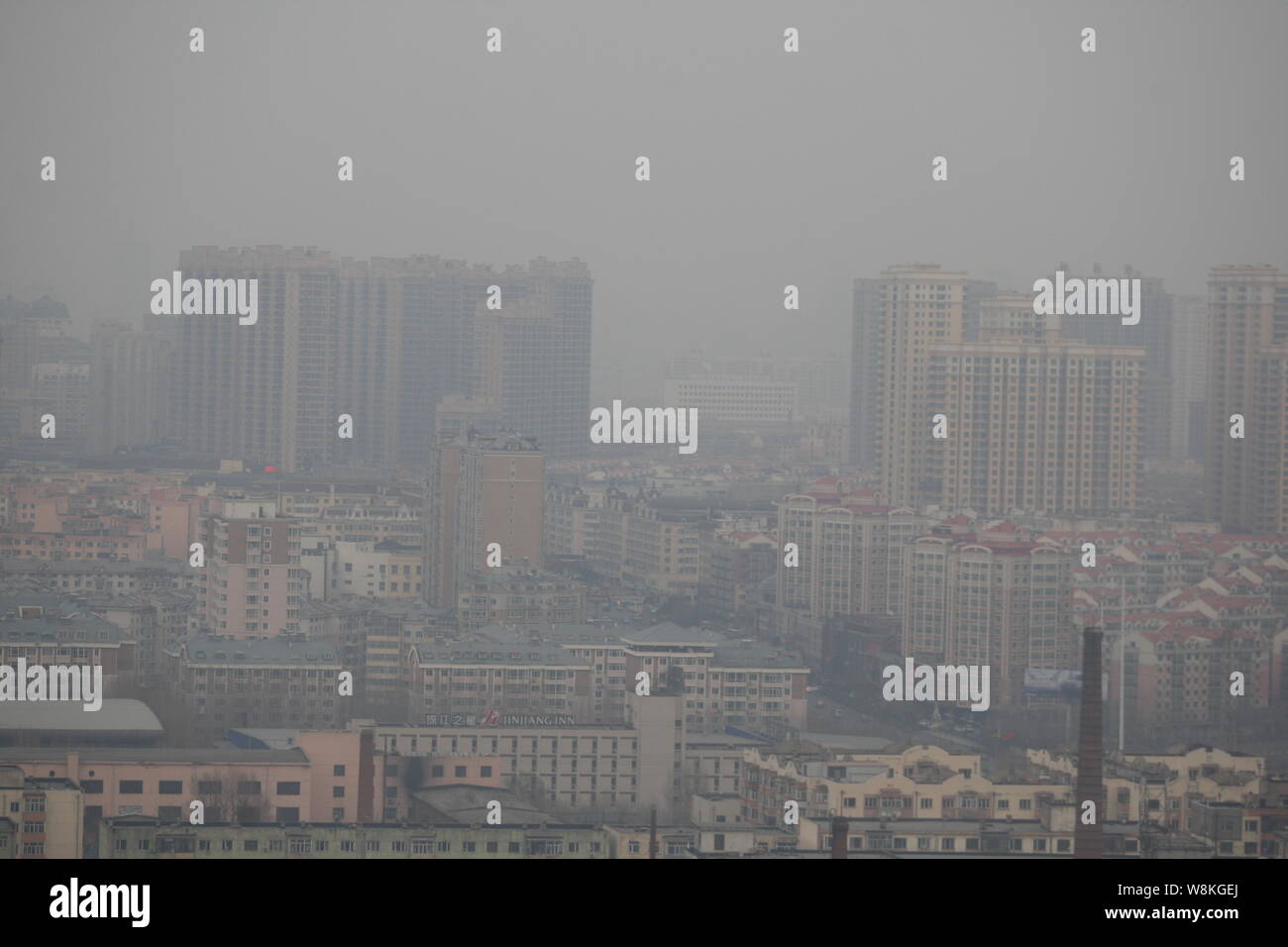 High-rise buildings are seen vaguely in a heavy sandstorm in Harbin ...
