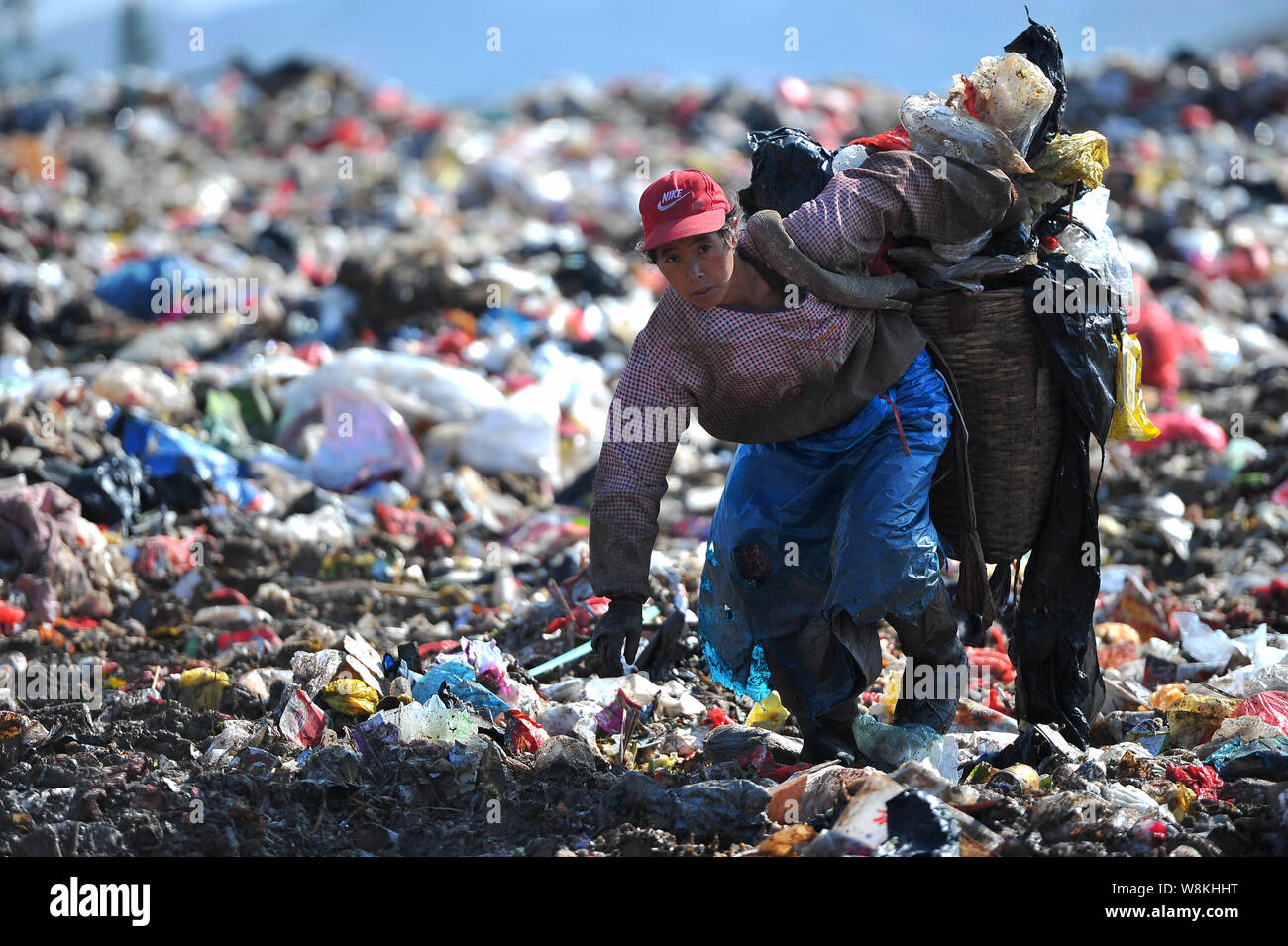 --FILE--A Chinese scavenger searches for useful and recyclable things ...