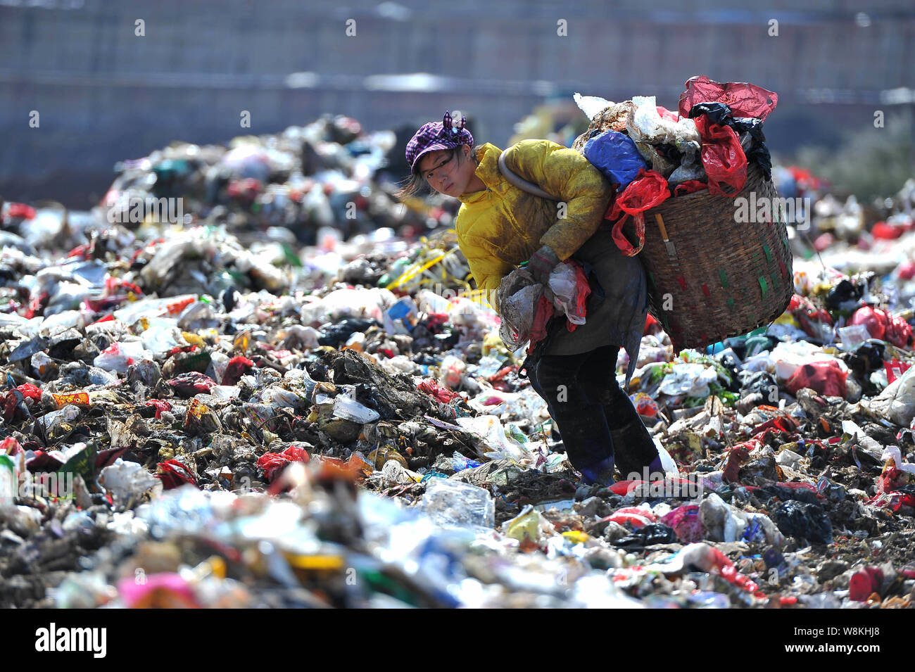 --FILE--A Chinese scavenger searches for useful and recyclable things ...