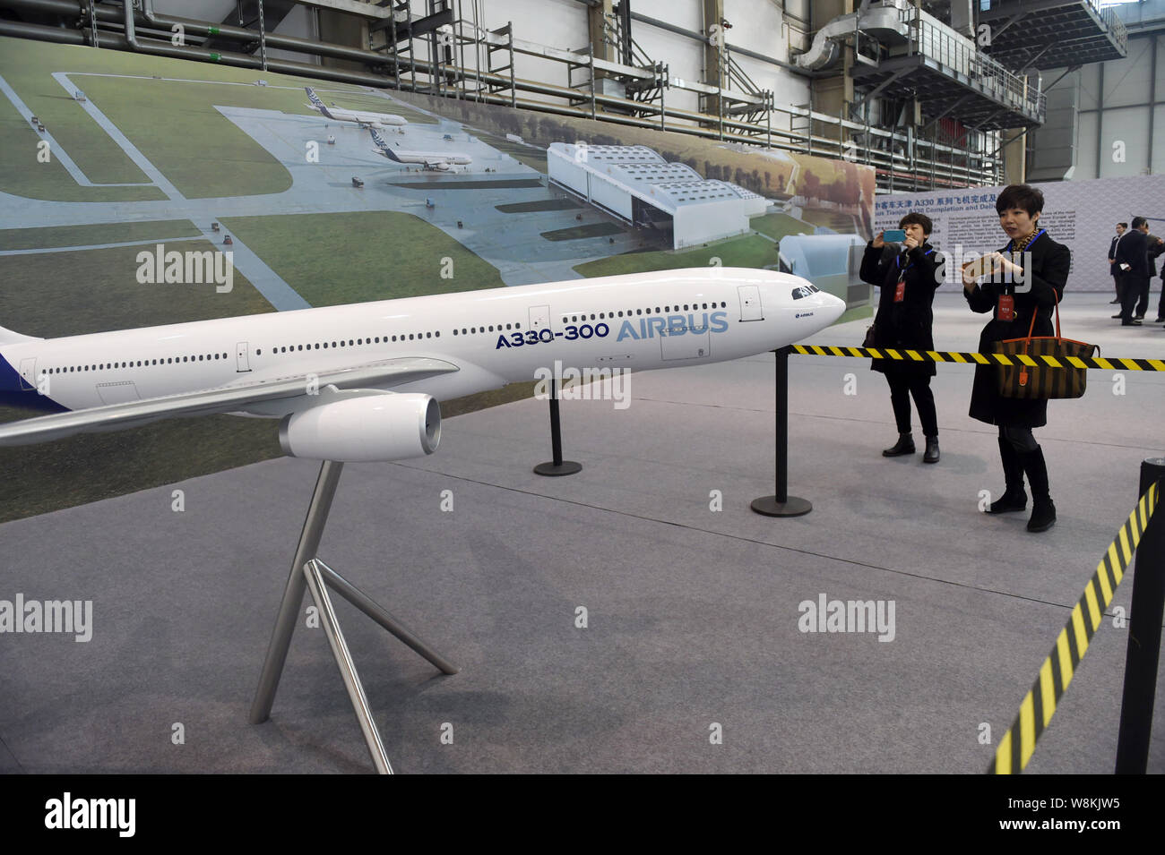 Visitors take pictures of a model plane of the Airbus A330-300 during ...