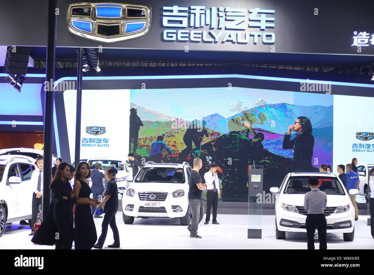 --FILE--People visit the stand of Geely during the 13th China ...