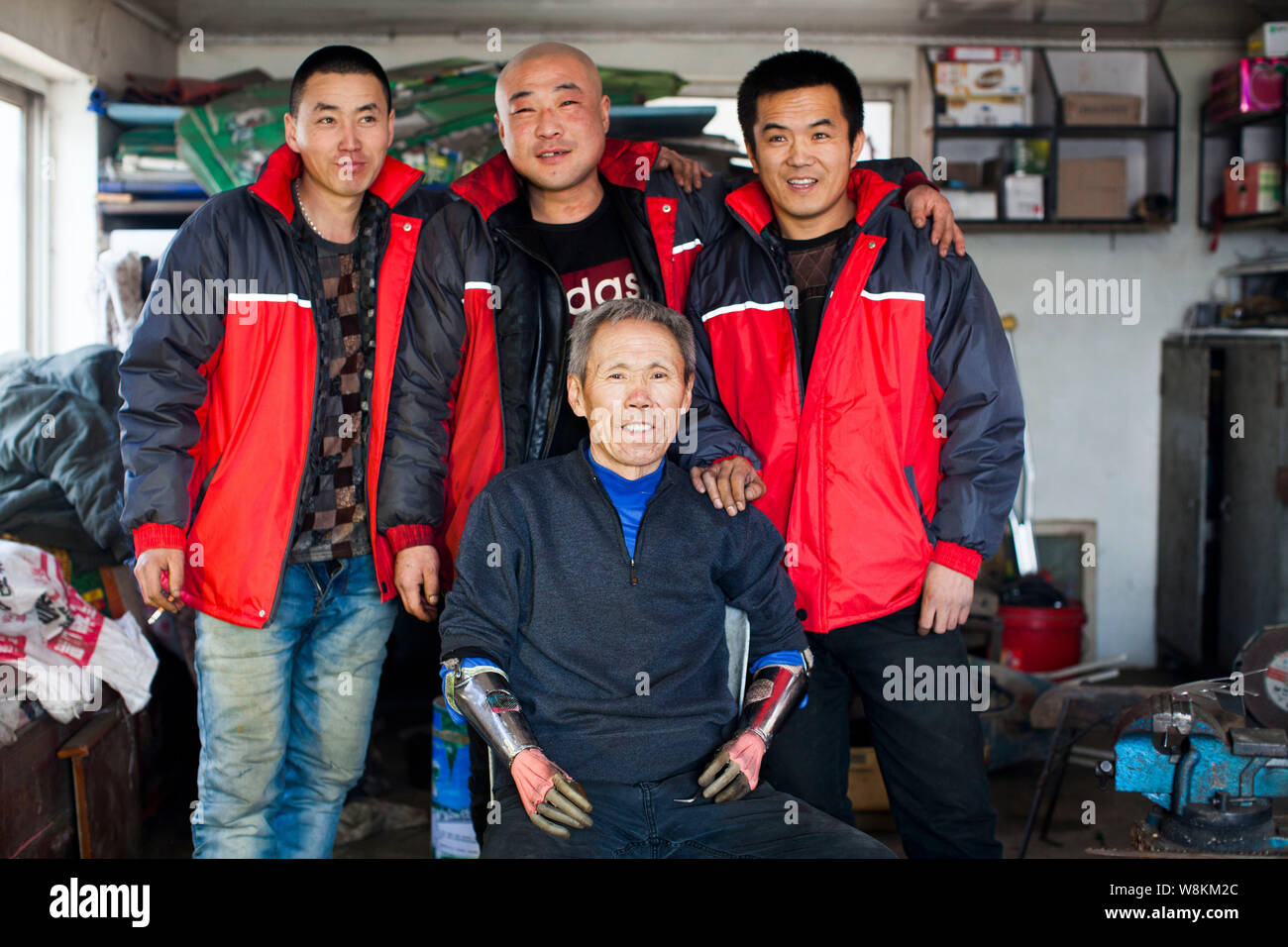 63-year-old armless farmer Sun Jifa, front, who is equipped with his ...